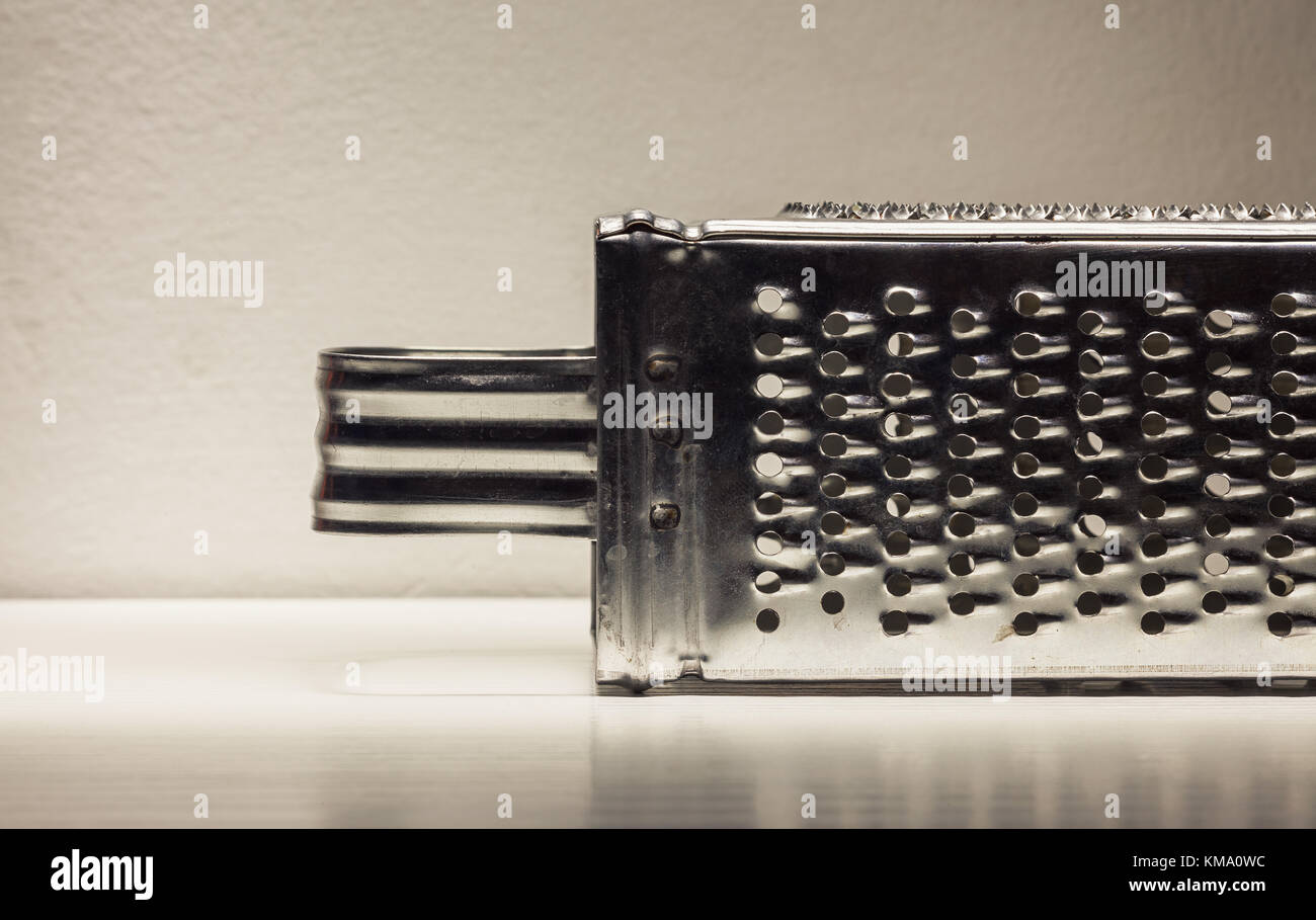 Closeup view on classical kitchen grater Stock Photo - Alamy