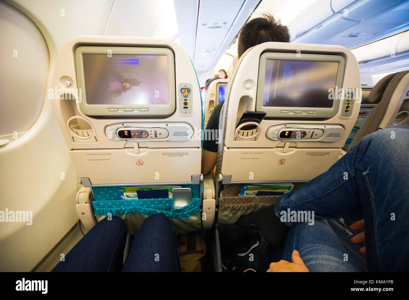 Watching film in monitor in airplane cabin during flight Stock Photo ...