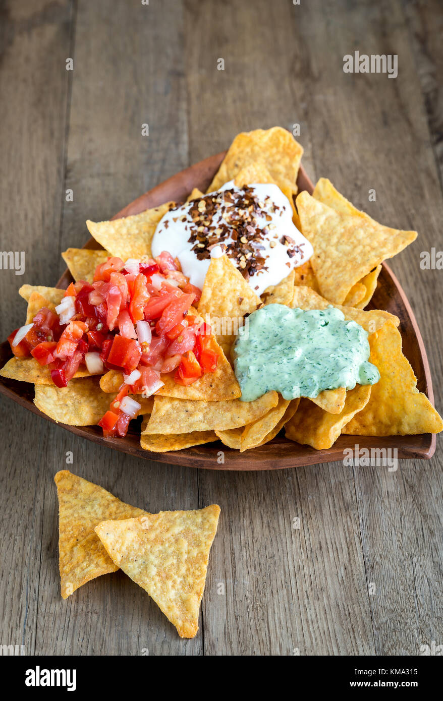 Cheese nachos with different types of sauce Stock Photo - Alamy