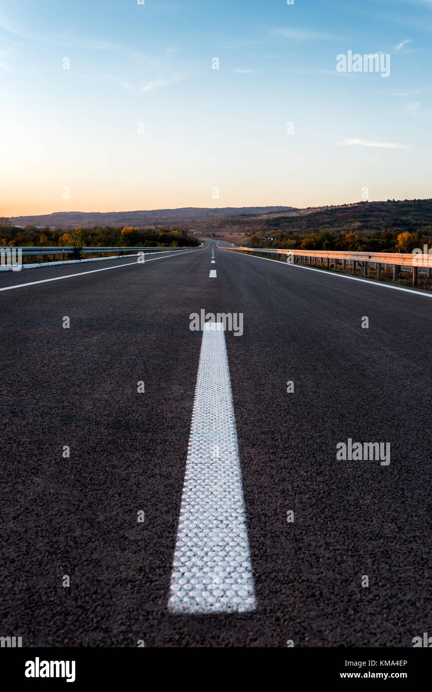 Empty Highway road with markings at sunset Stock Photo - Alamy