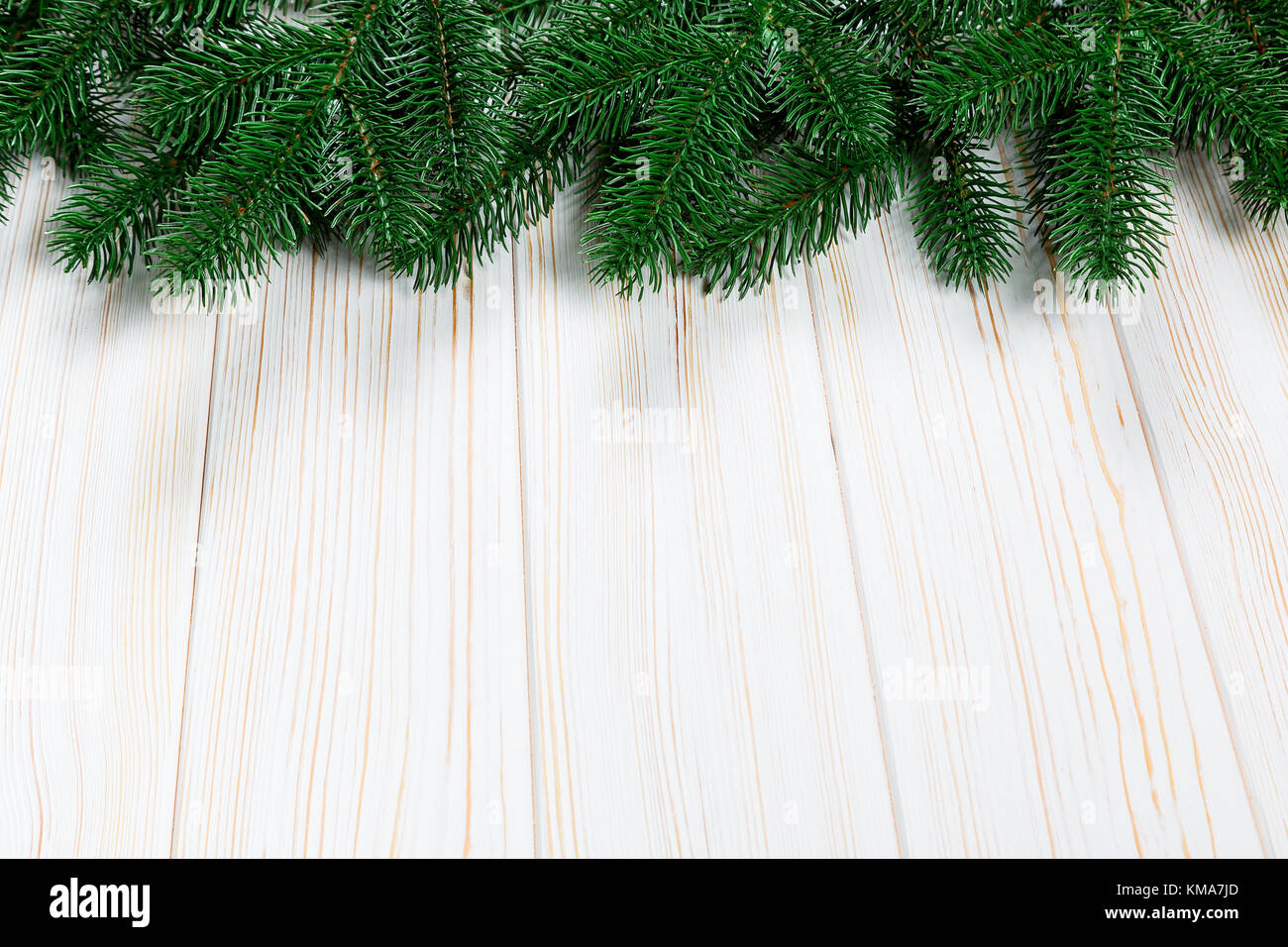 Christmas fir tree on white wooden background. Free space. Winter frame ...