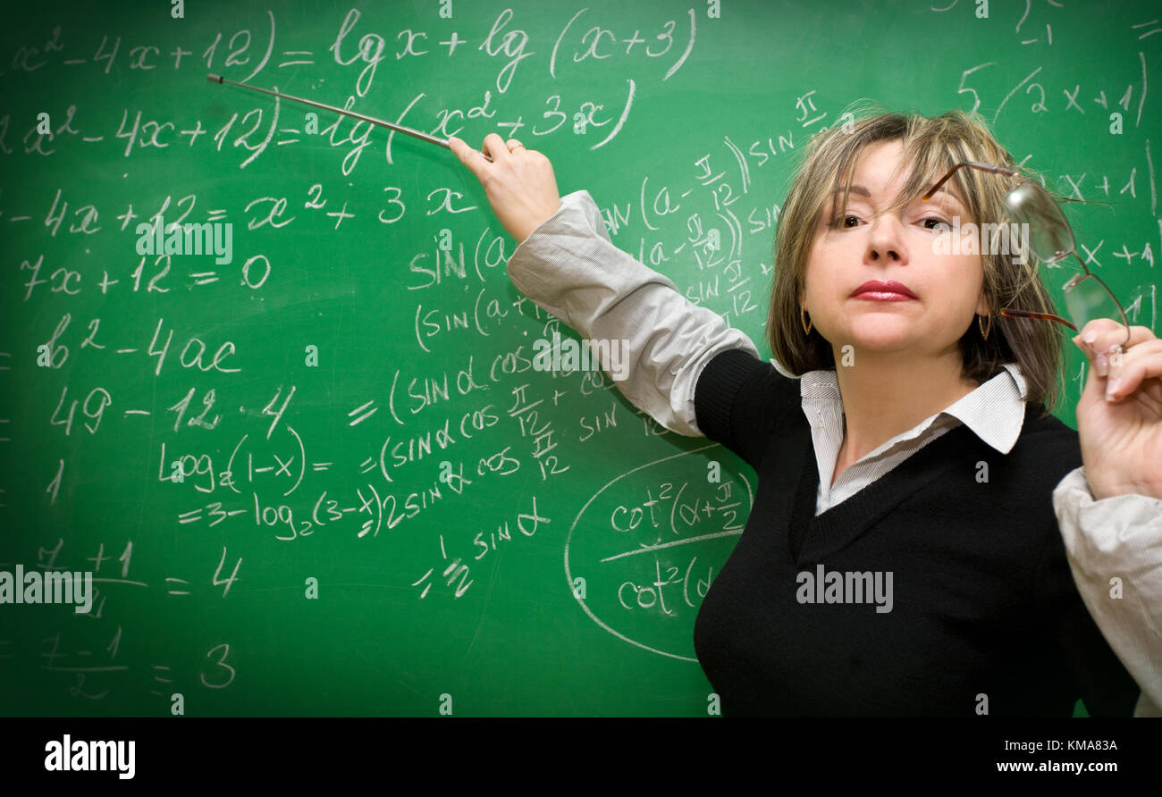 teacher shows the formula on the green chalkboard Stock Photo - Alamy