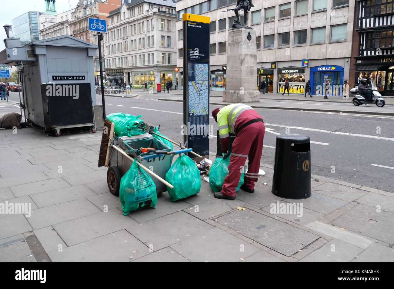 litter man picking up bags of rubber Stock Photo - Alamy
