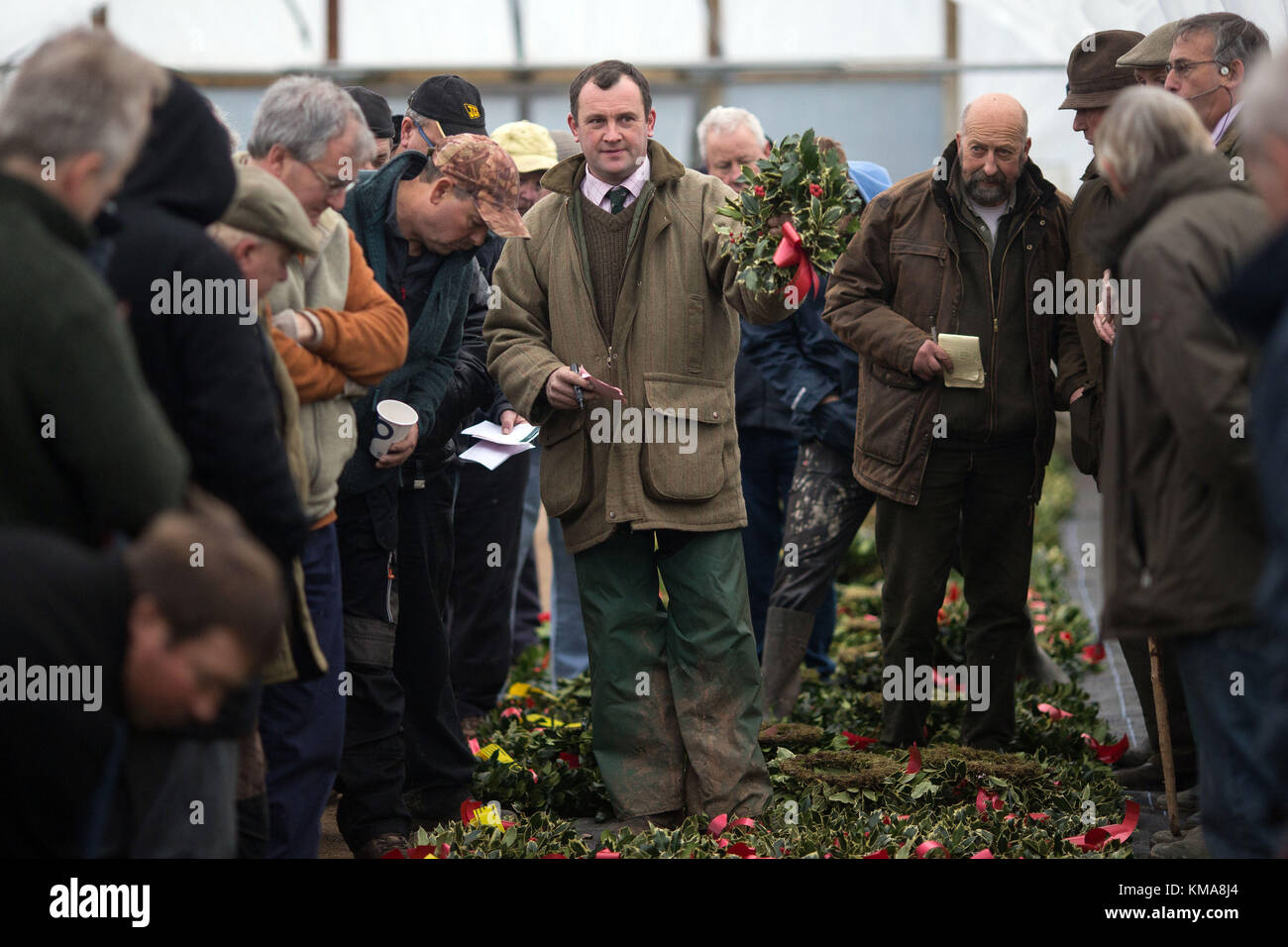 A man auctions wreathes during the annual mistletoe and holly auction ...