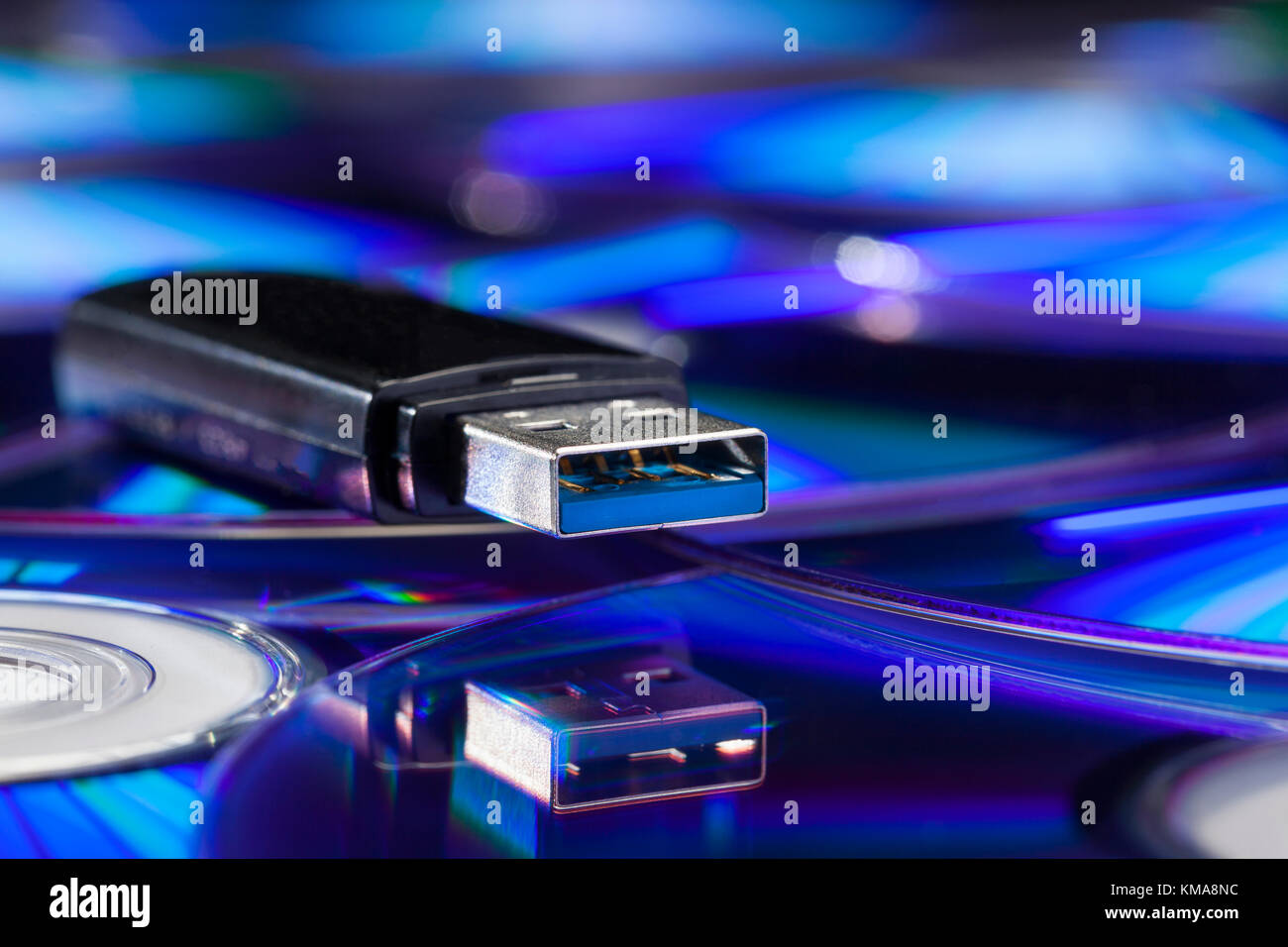 Usb stick and its reflection on a pile of cds Stock Photo - Alamy