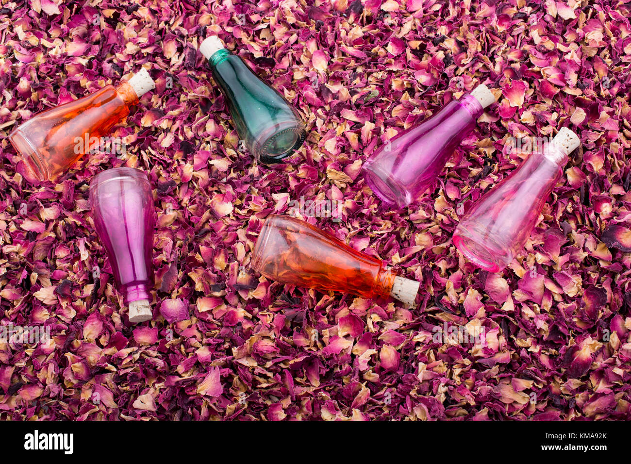 Colorful empty bottles on dry rose petal background Stock Photo - Alamy