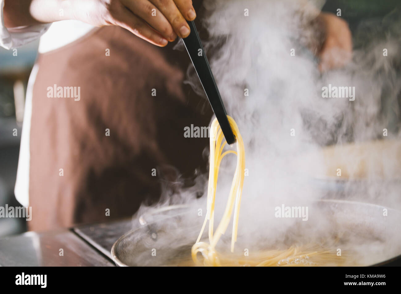 Chef cooking spaghetti in restaurant Stock Photo - Alamy