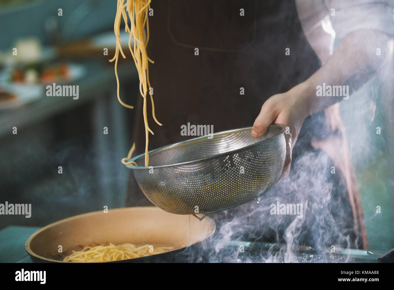 Process of cooking spaghetti in restaurant Stock Photo - Alamy