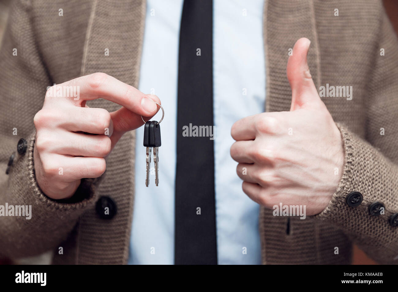 Businessman hands showing key and thumb up Stock Photo - Alamy