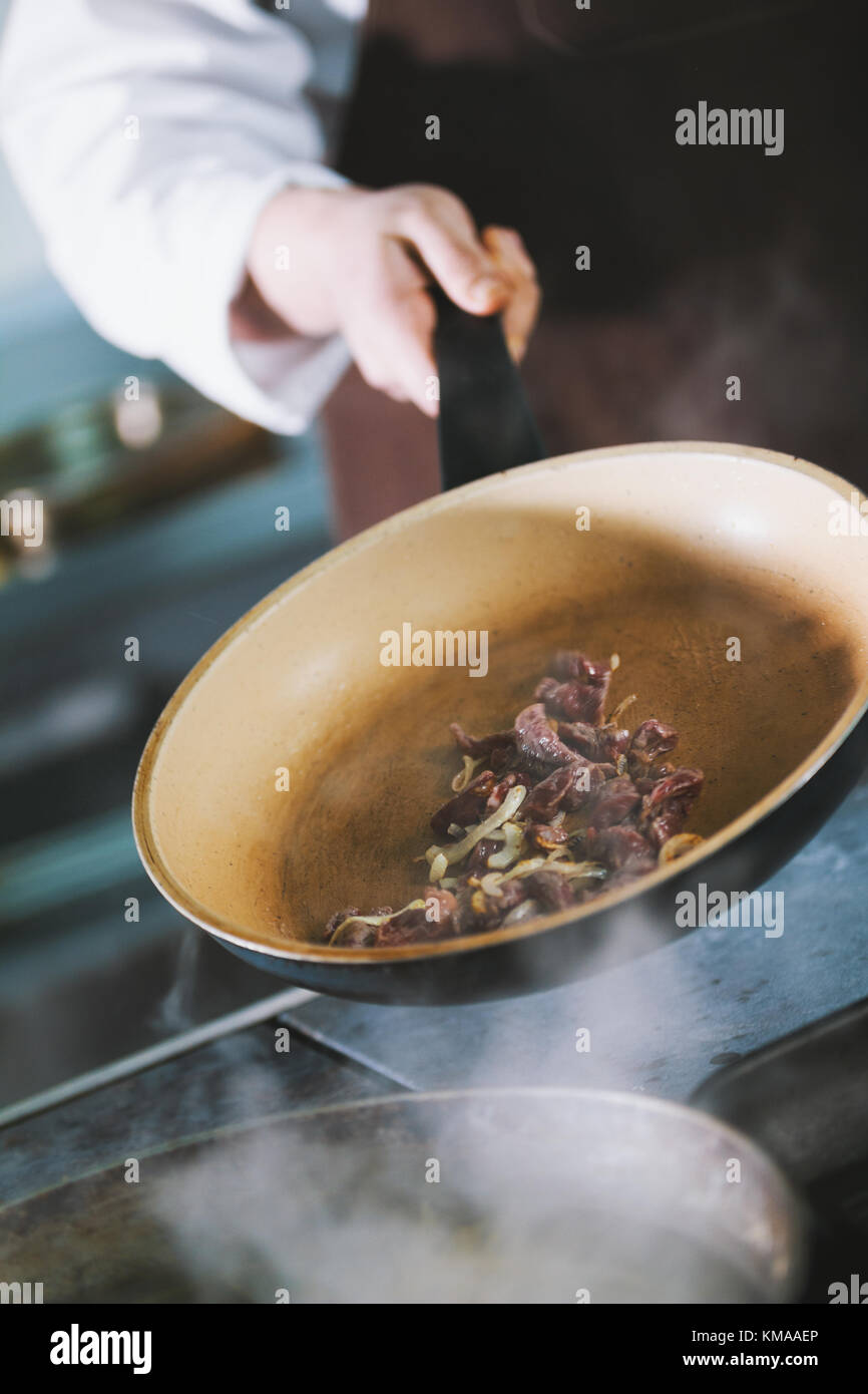 The process of frying meat in a pan Stock Photo - Alamy