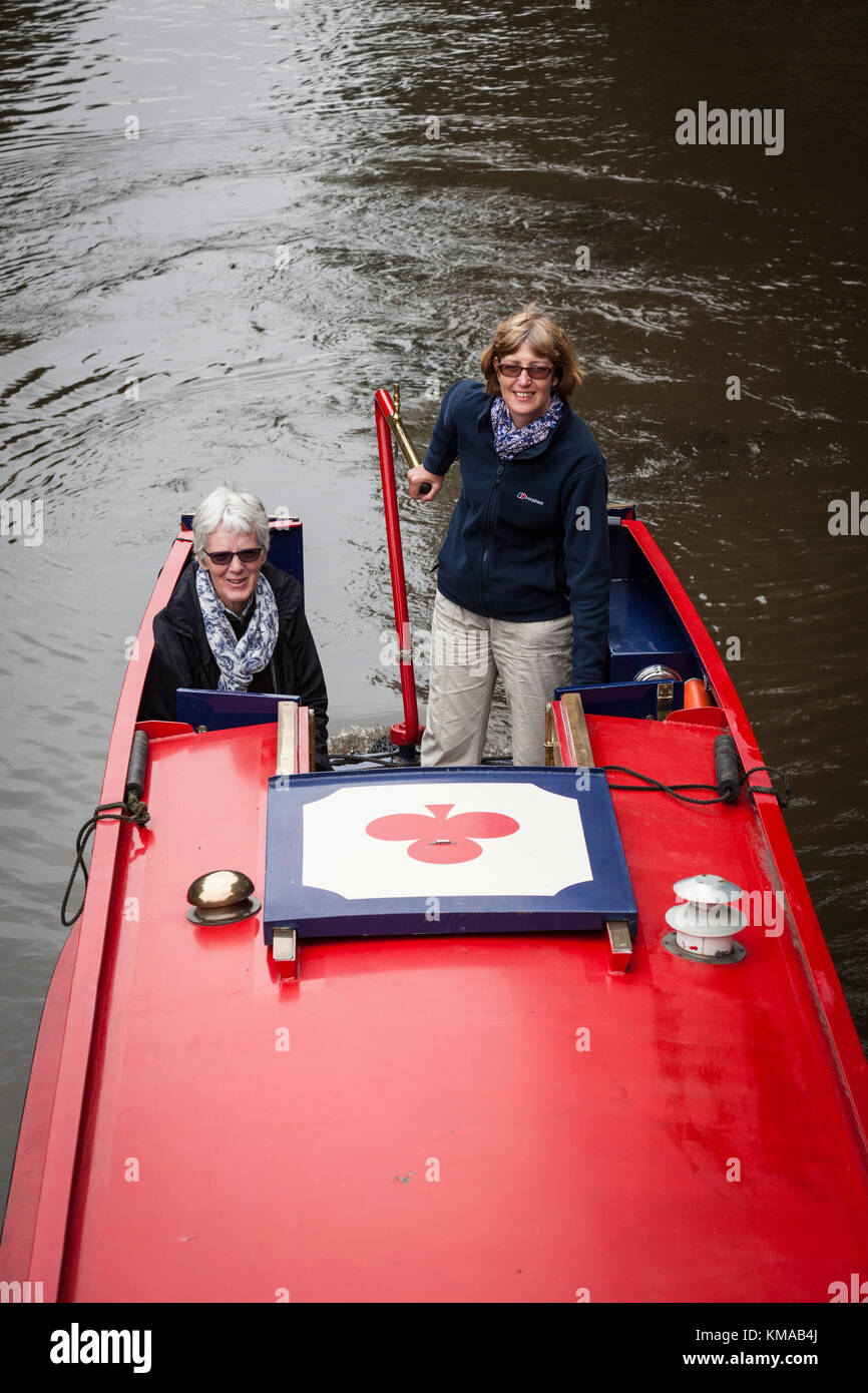 Viewed from above, two women steer their narrowboat along the Trent ...