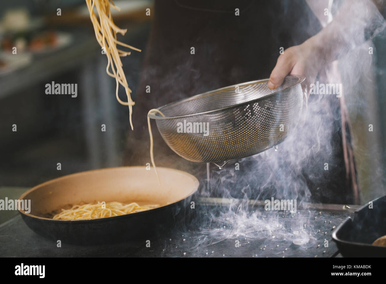 Cooking spaghetti in restaurant Stock Photo - Alamy