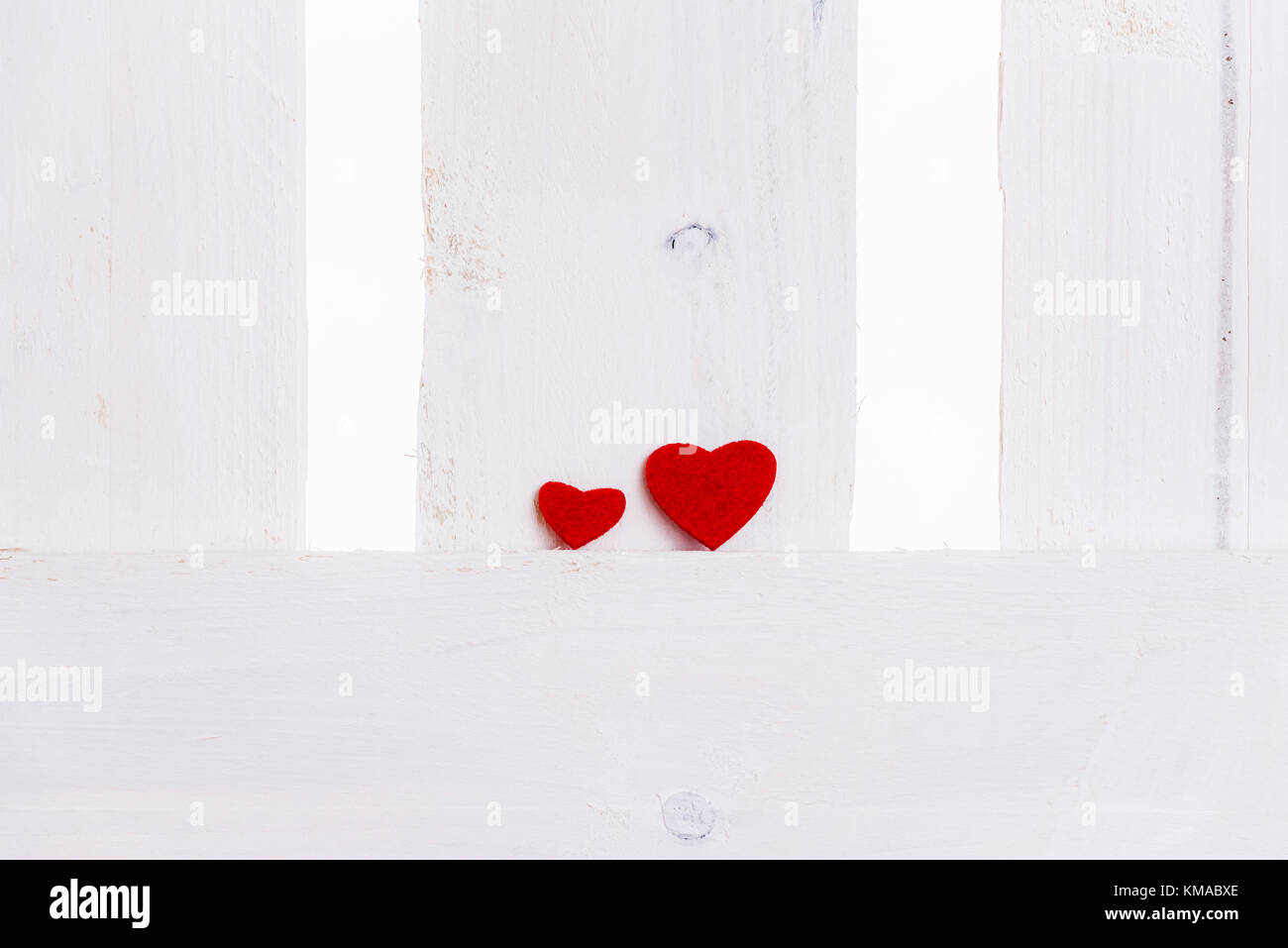Relationship theme image with a big red heart next to a smaller one on ...