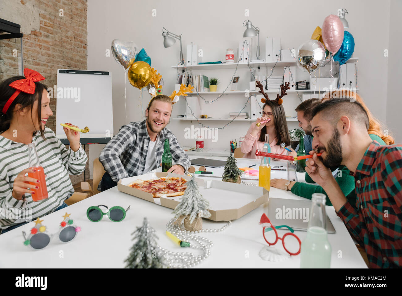 Friends and colleagues celebrating Christmas in the office Stock Photo ...