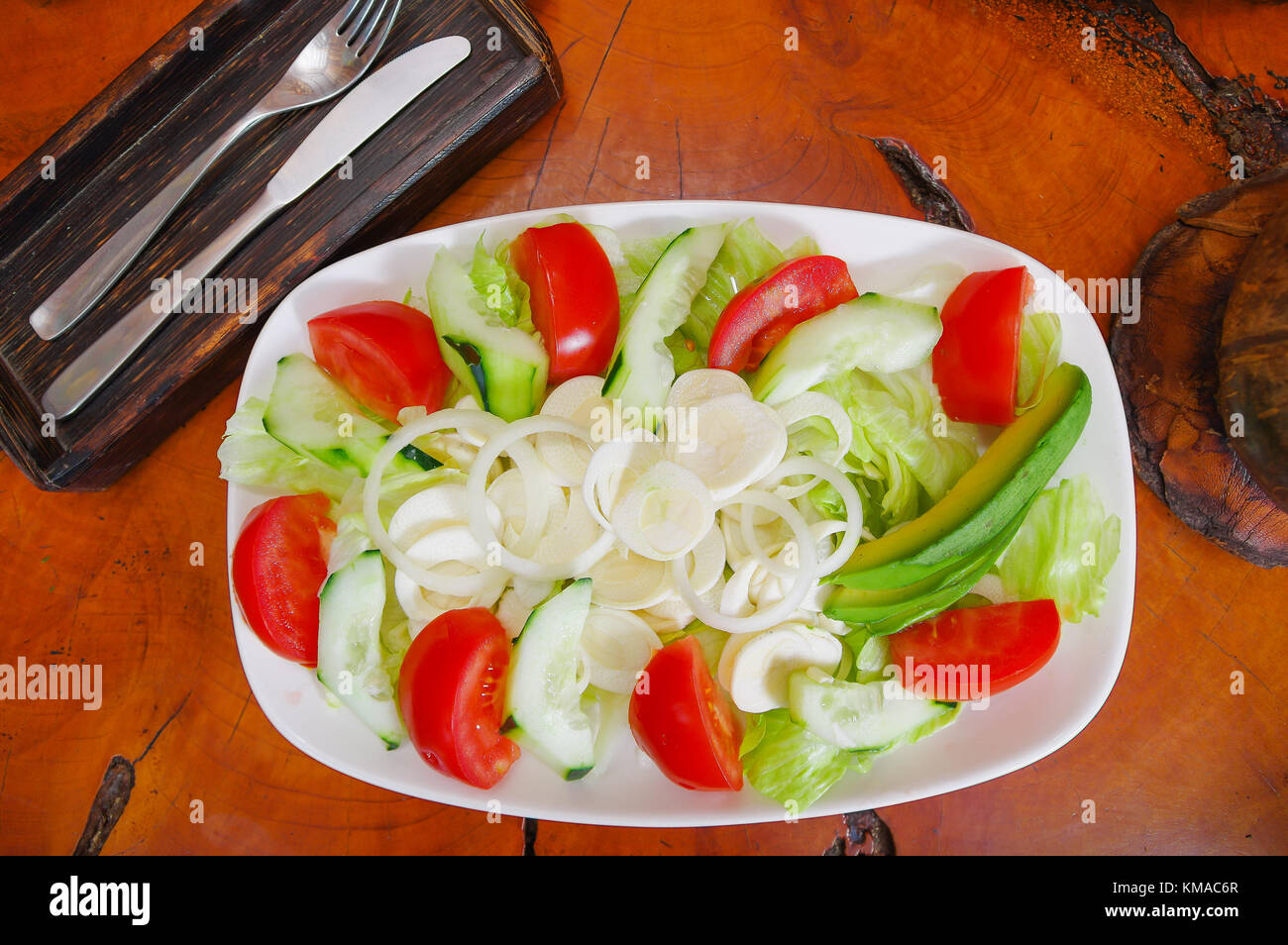 Above view of fresh salad with vegetables, tomato, onion, palmito ...