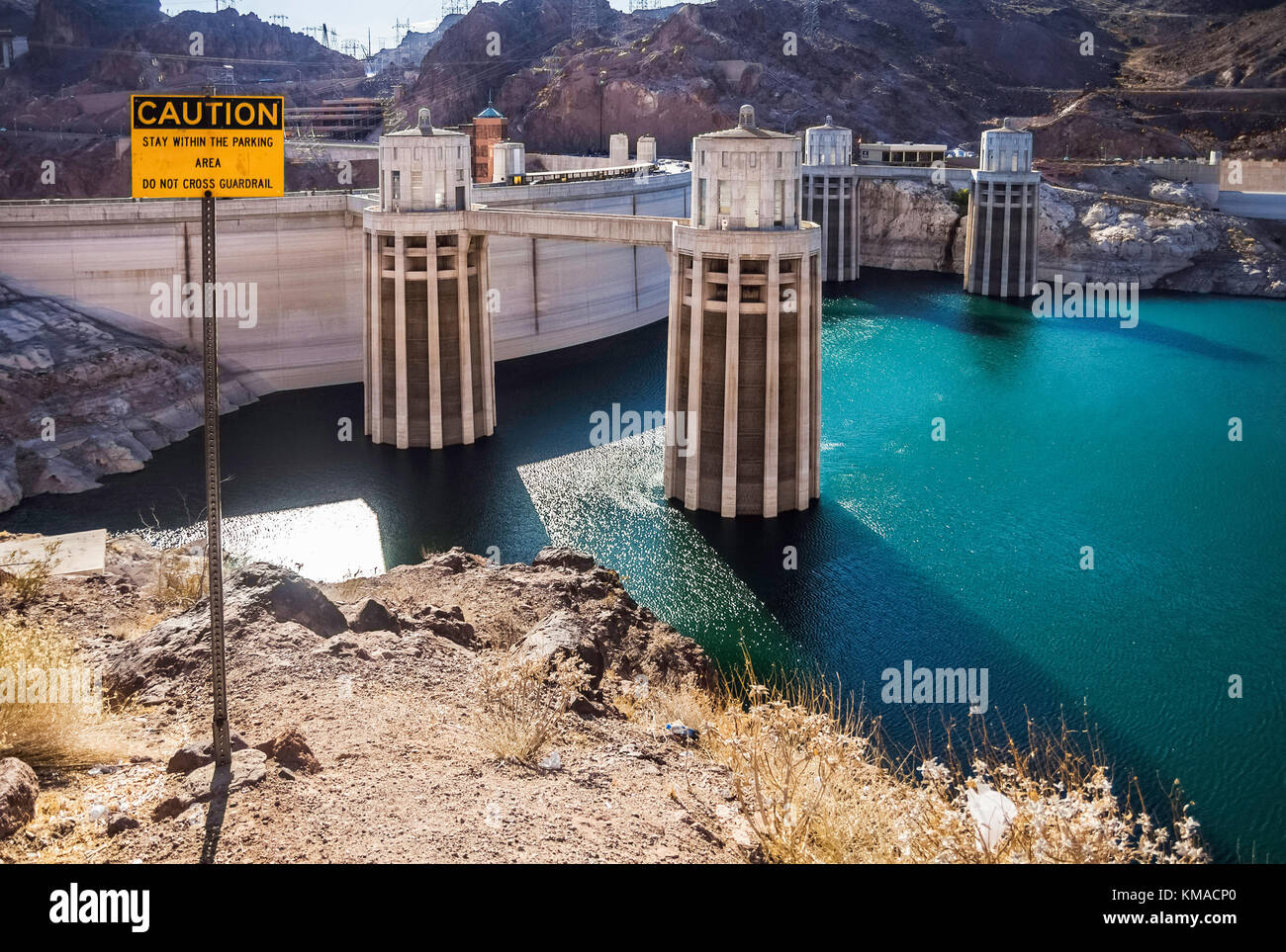 Hoover dam and Colorado River with a warning sign in the foreground ...