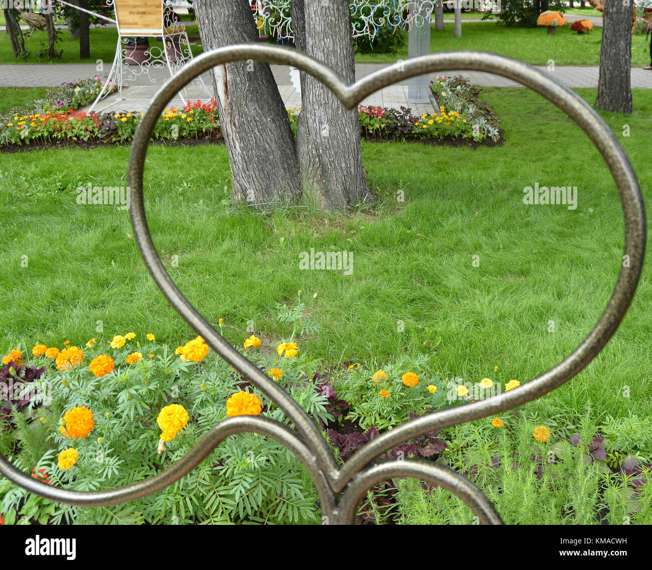 Metal pattern heart symbol, look through the heart on the grass, Park ...