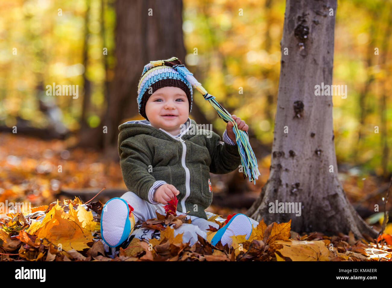 Baby boy in fall forest Stock Photo - Alamy