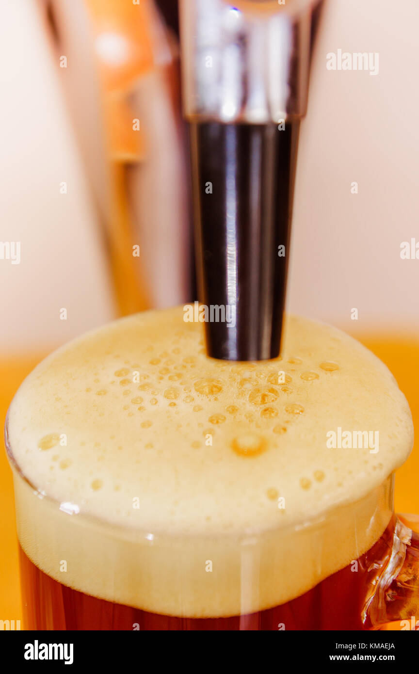 Close up of a glass of beer with foam and beer tap pouring, beer ...