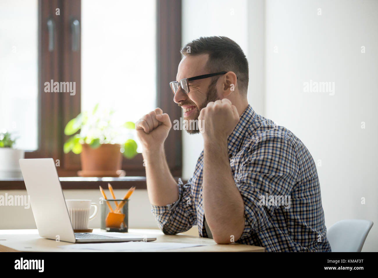 Young happy manager celebrating his victory in job. Millennial bearded ...