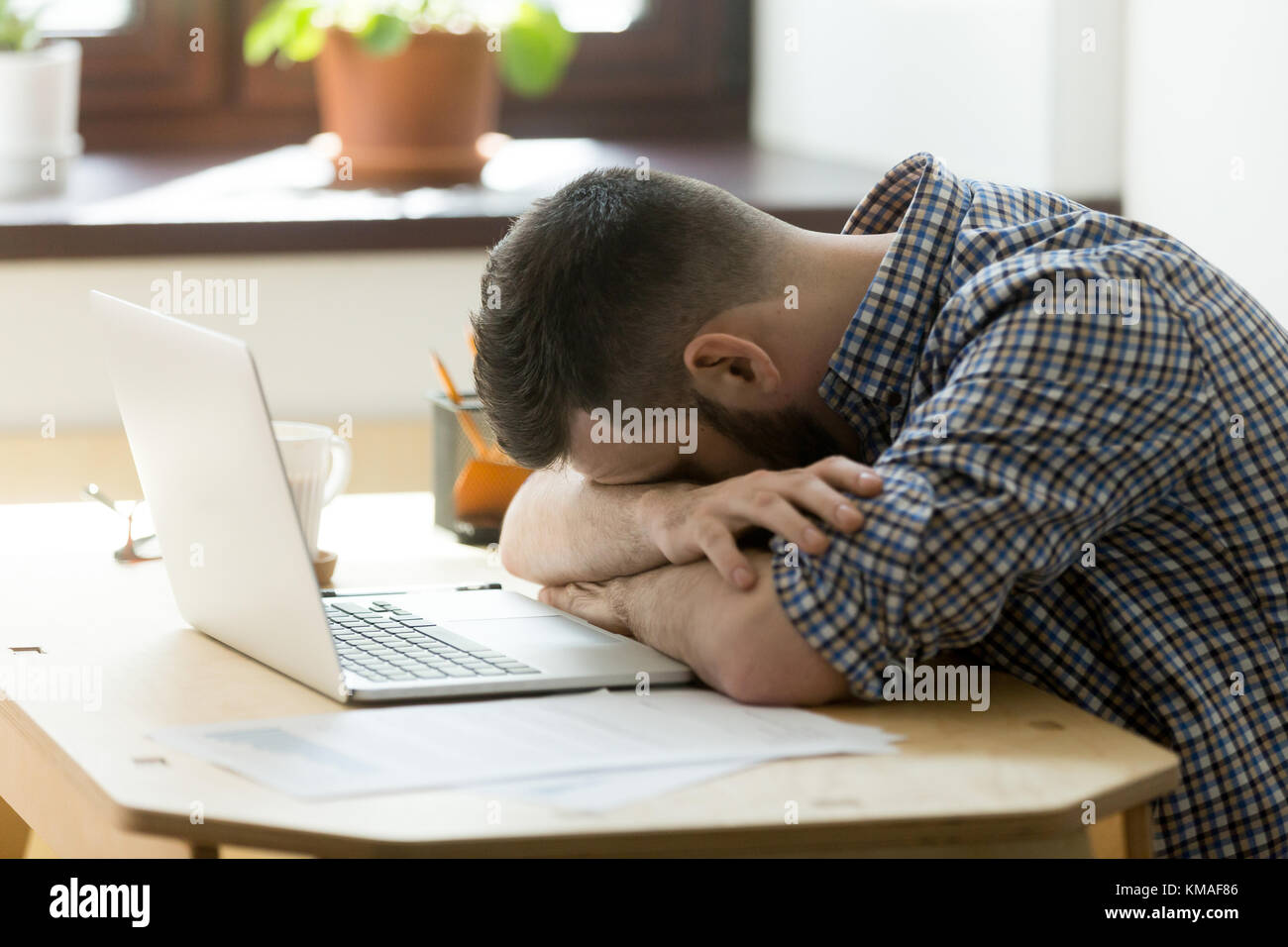 Tired manager falling asleep over laptop in hard working day in home ...