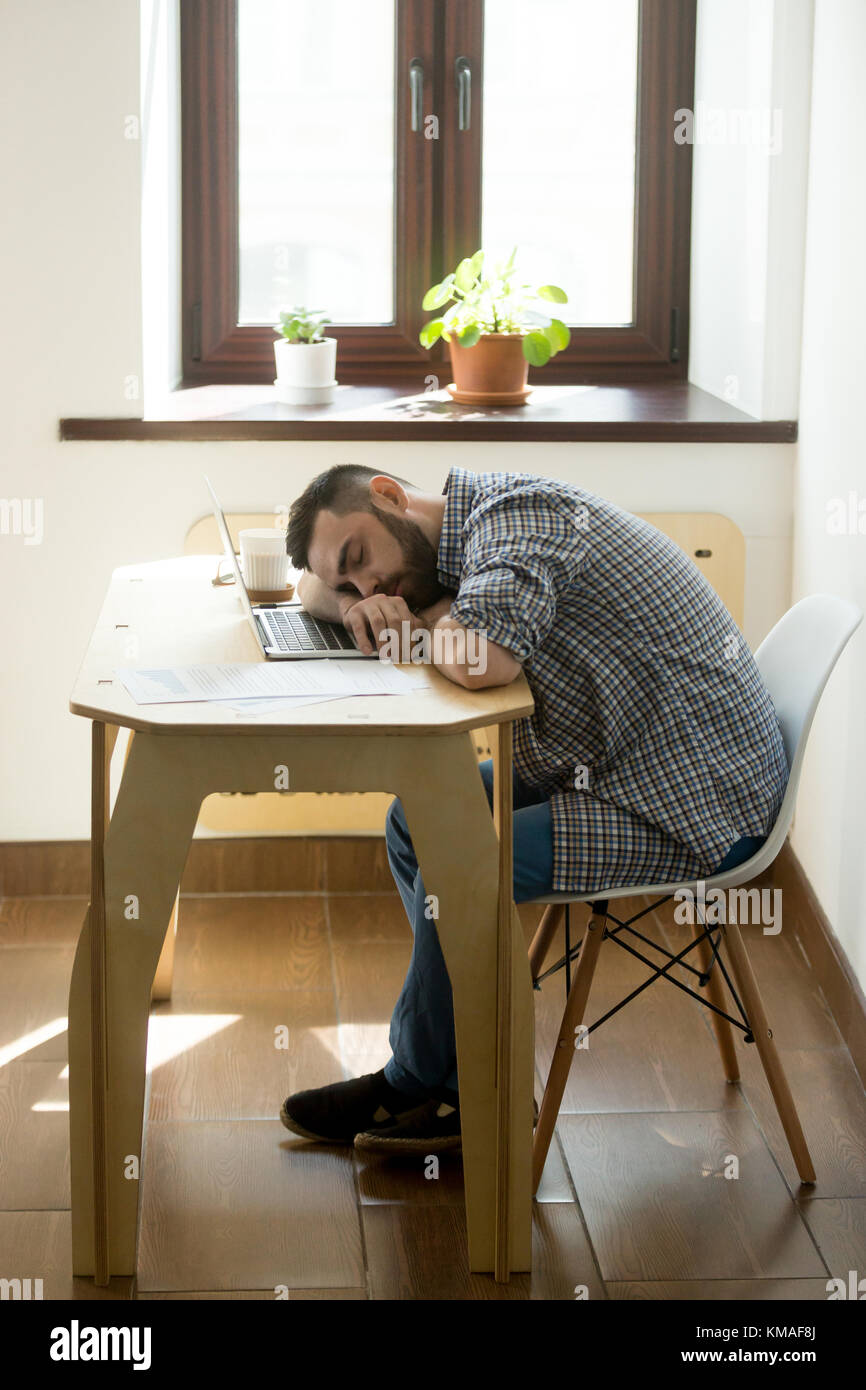 Fatigued casual businessman tired from hard working routine and fell ...