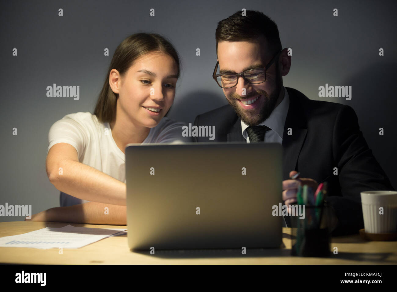 Young beautiful female worker discussing job question with colleague ...