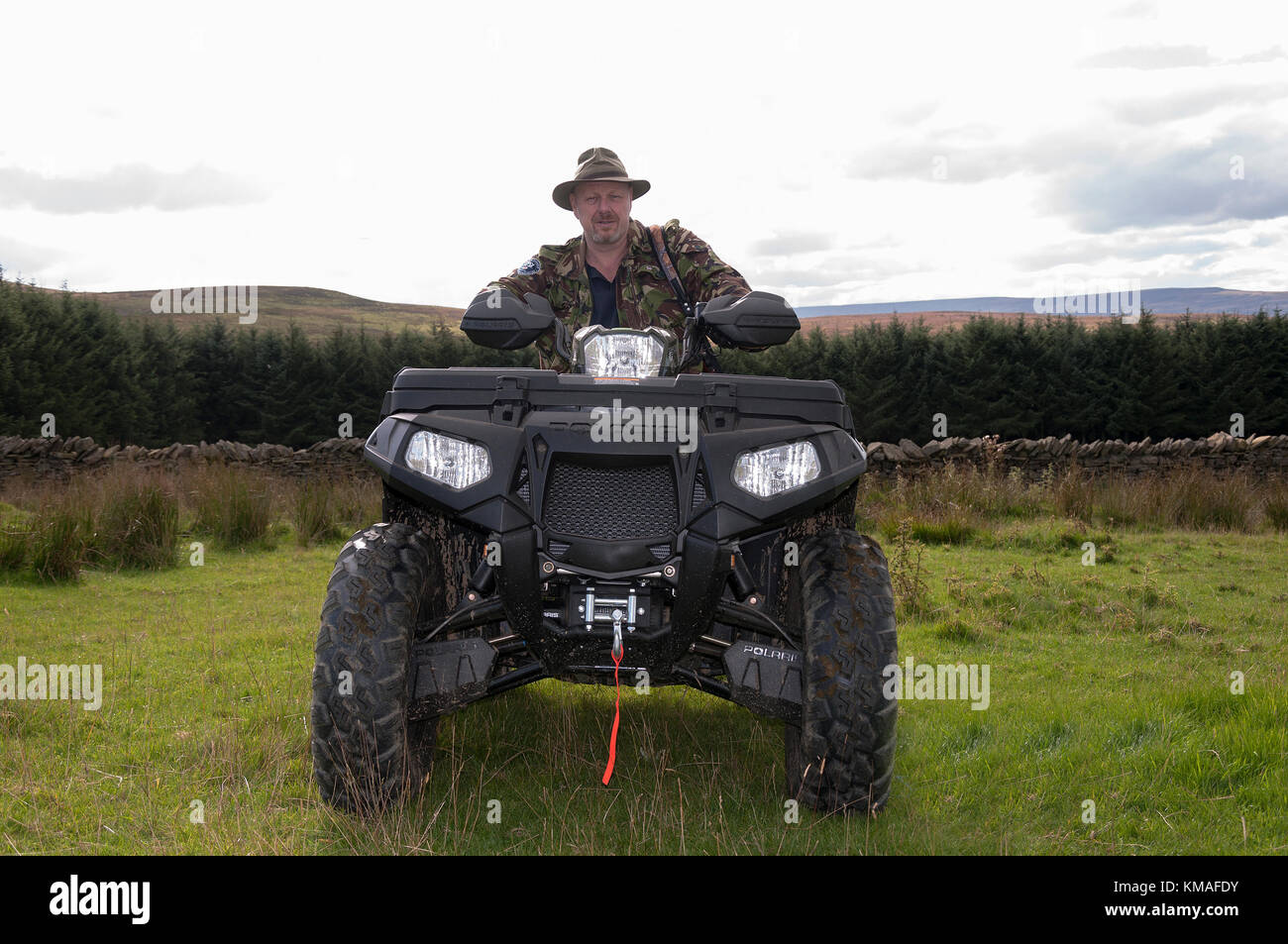 A man sitting on a quad (ATV) on a hunting trip in Weardale in County ...