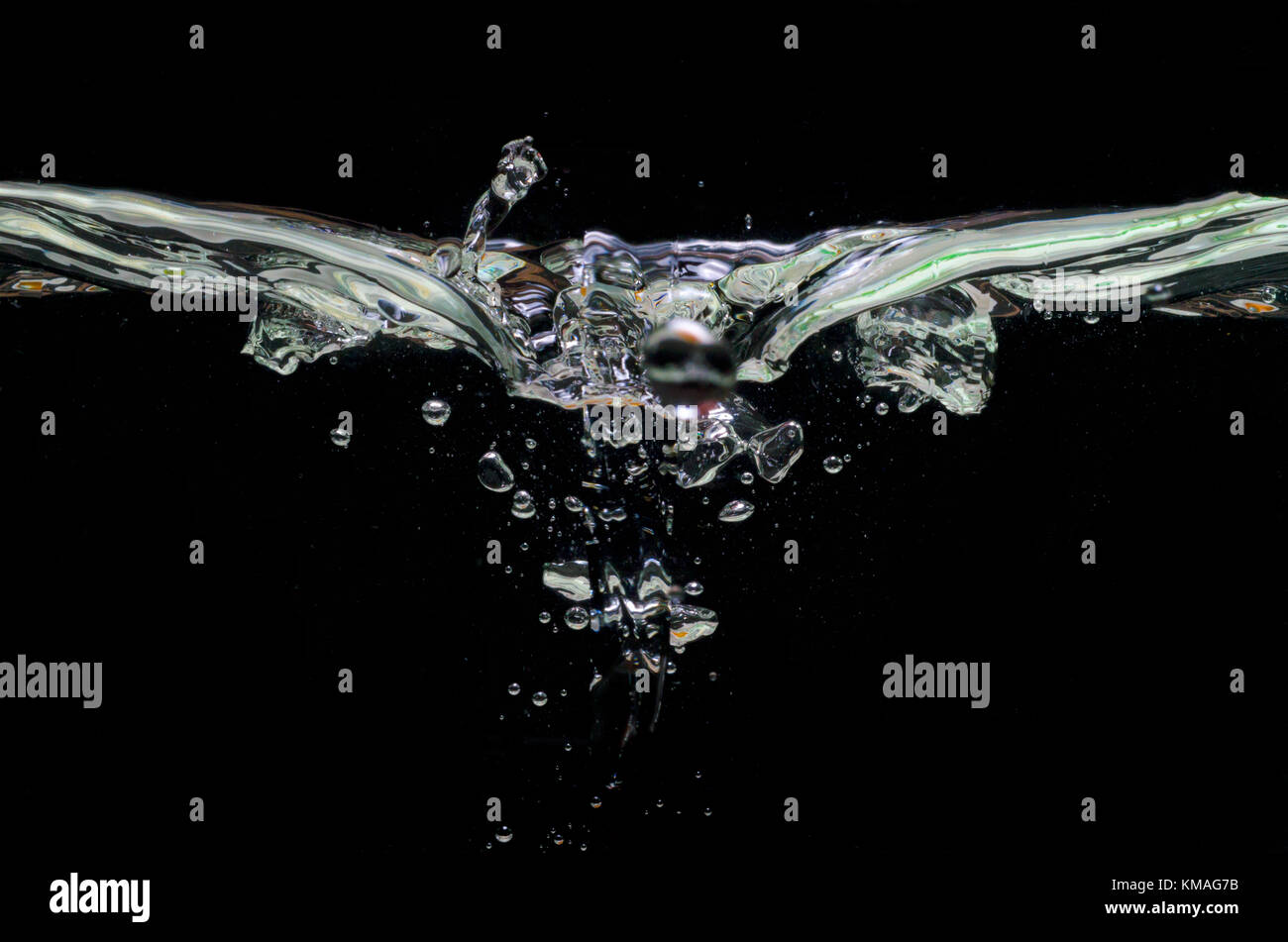 Strange shape of splashing water on black background Stock Photo - Alamy