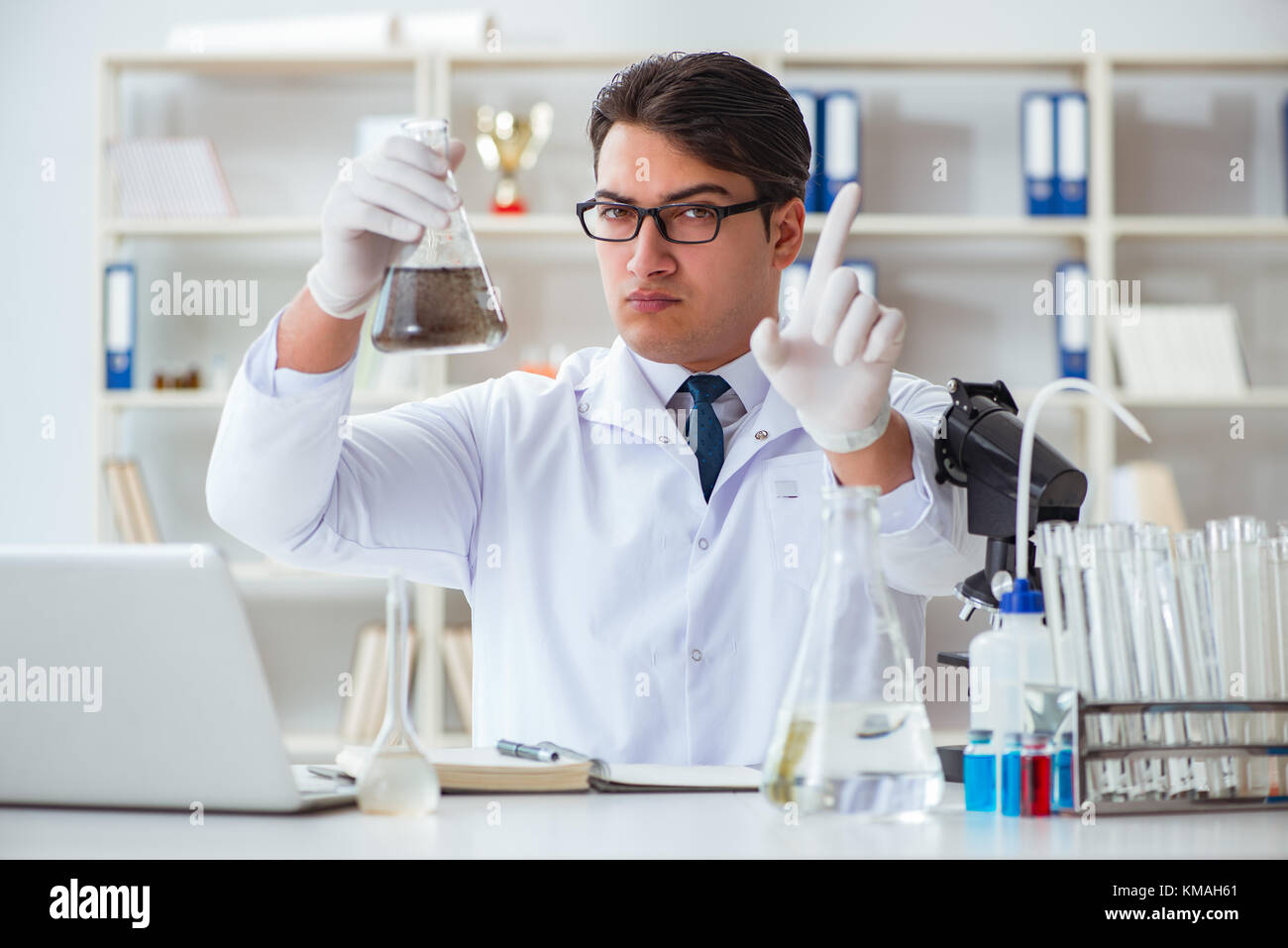 Young researcher scientist doing a water test contamination experiment ...