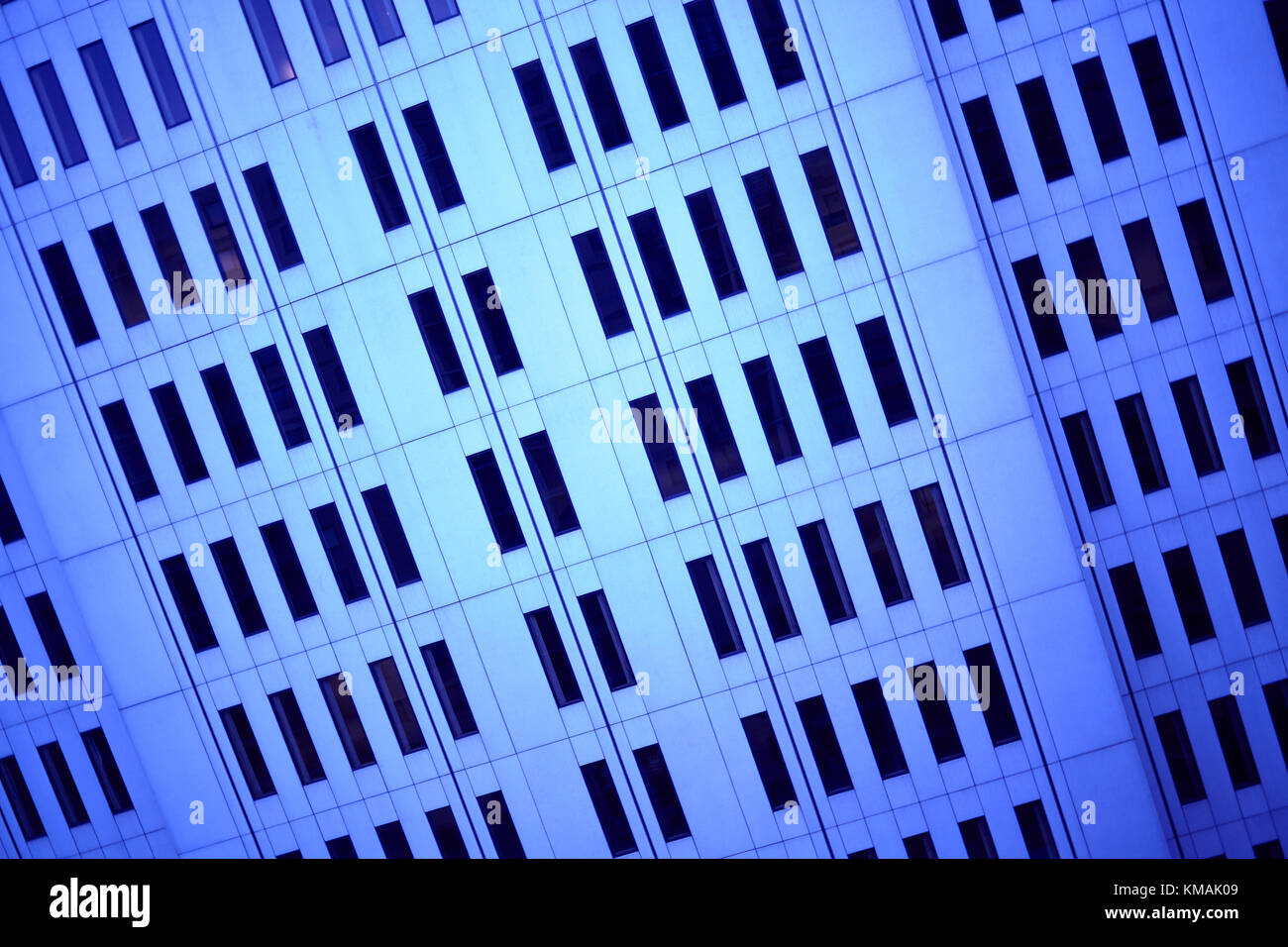 Full frame oblique view of the blue facade of a modern office building ...
