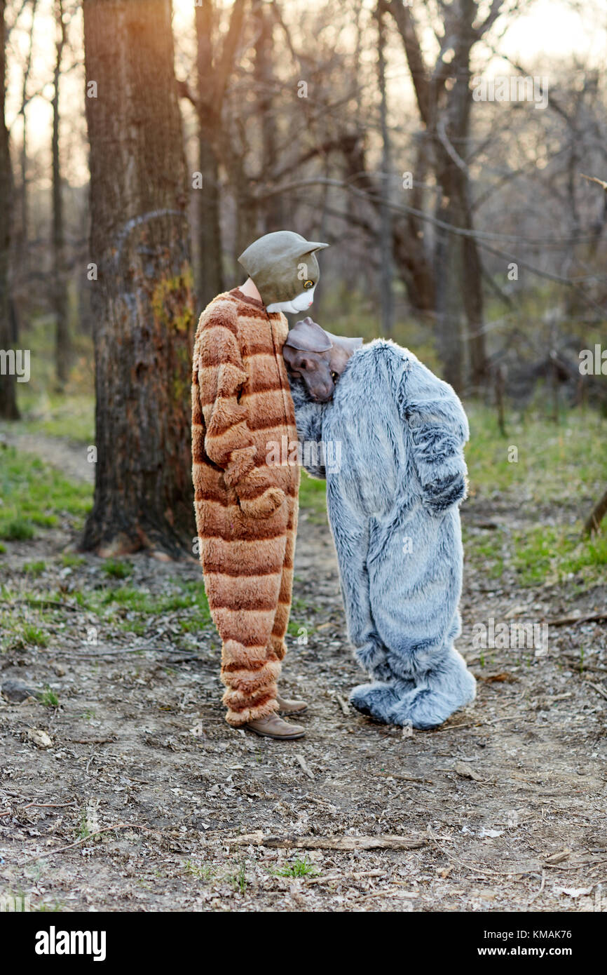 Full length side view of a funny couple wearing carnival cat and dog ...