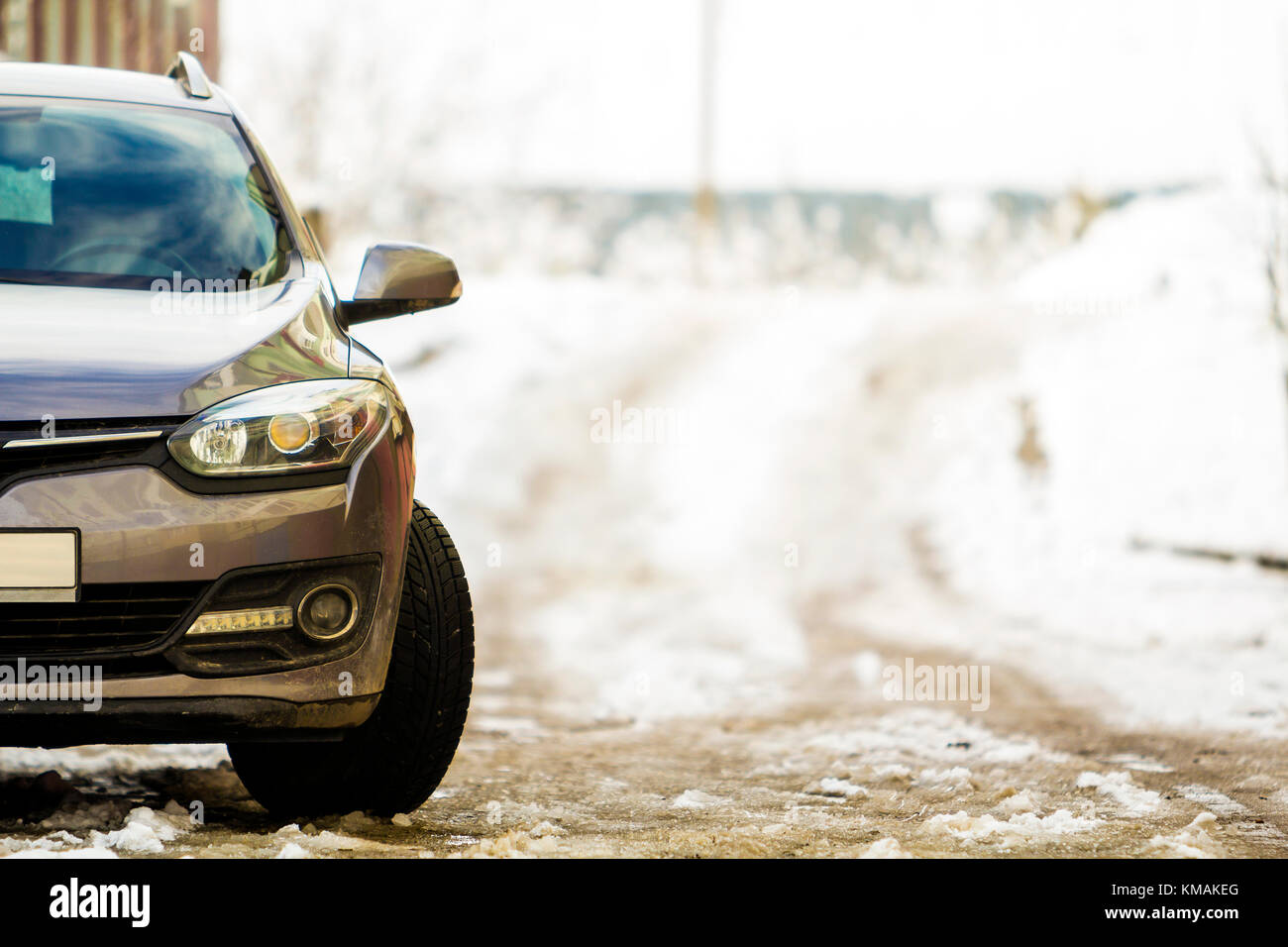 New modern grey car parked on a street in winter Stock Photo - Alamy