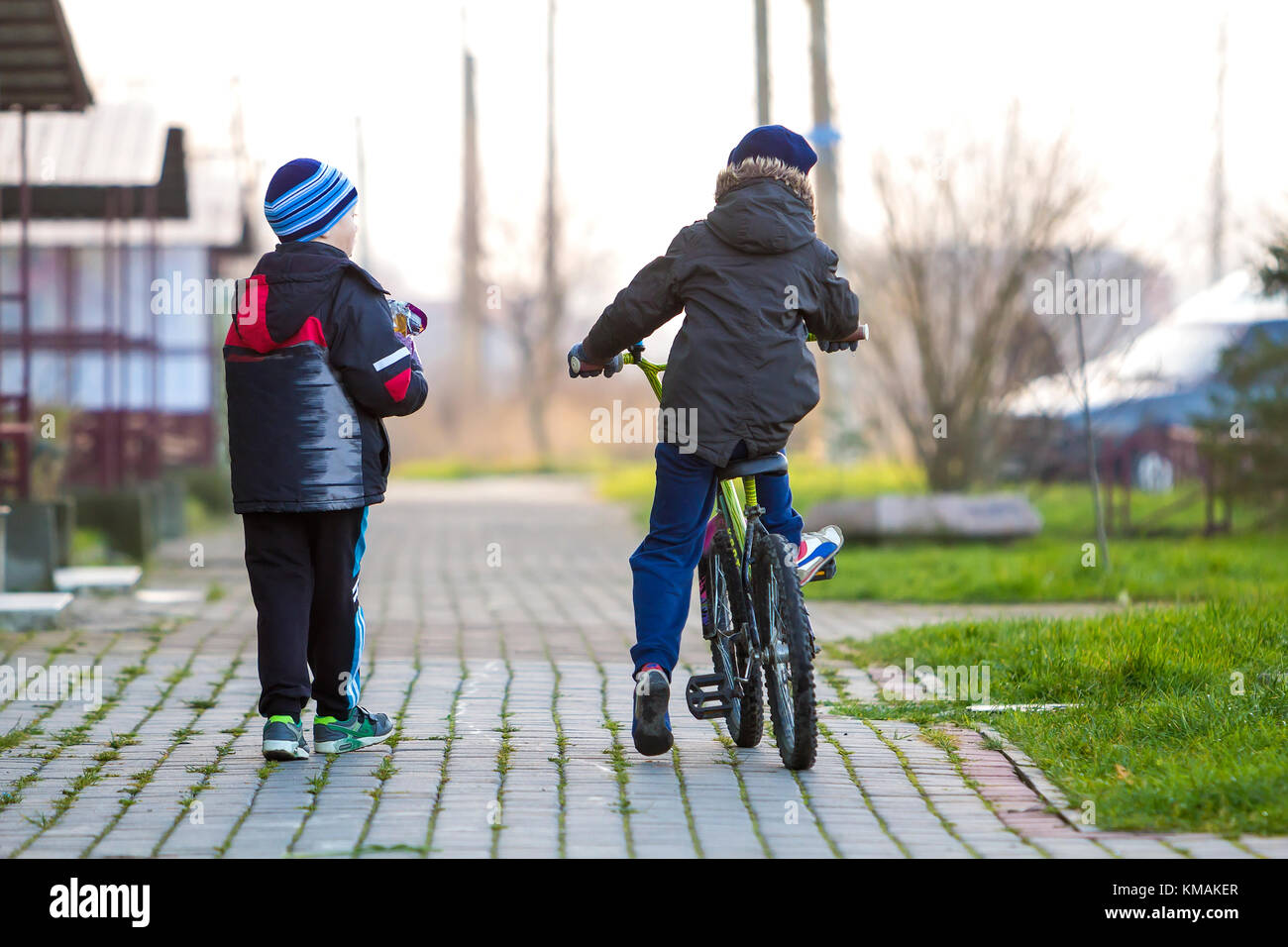 Boys friends on a bicycle outside. Children playing outdoors Stock ...