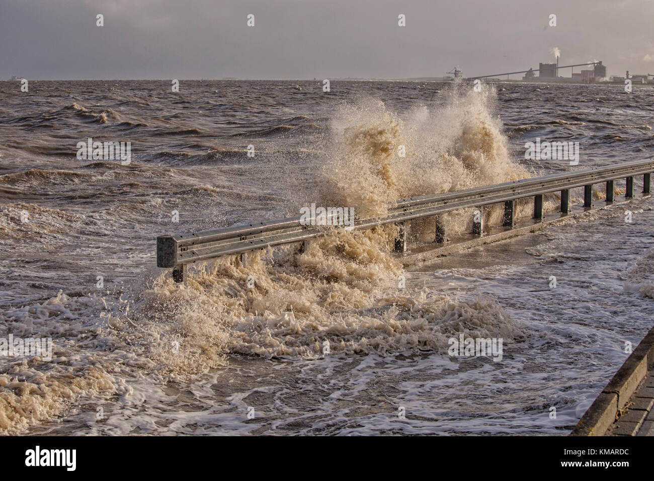 Waves of ocean water splashing on a Dutch dike after heavy rains and ...