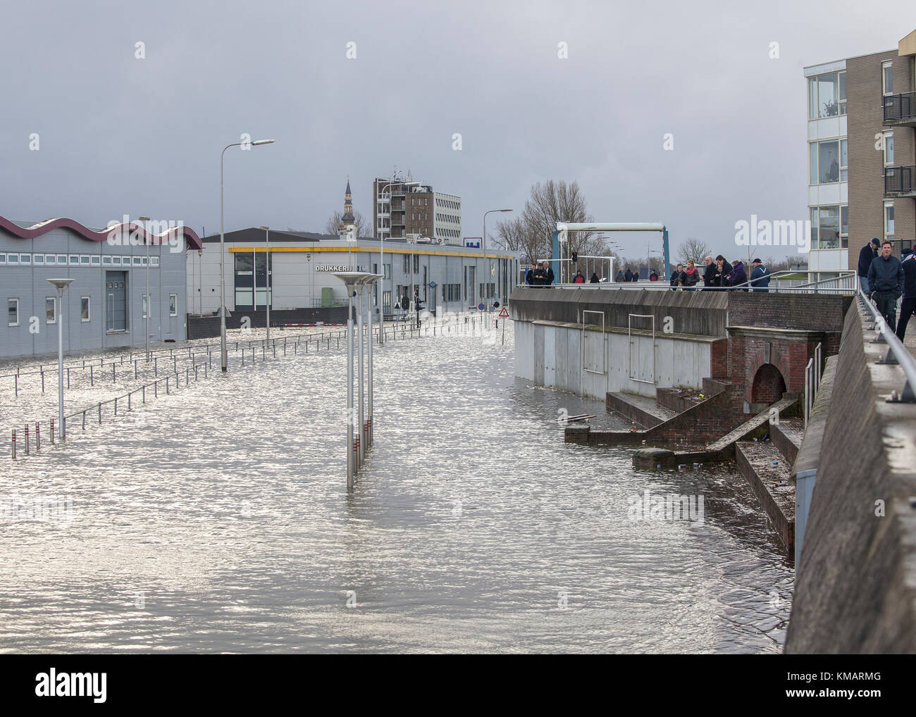 DELFZIJL, NETHERLANDS-DEC 6: Locals walk and watch their flooded town ...