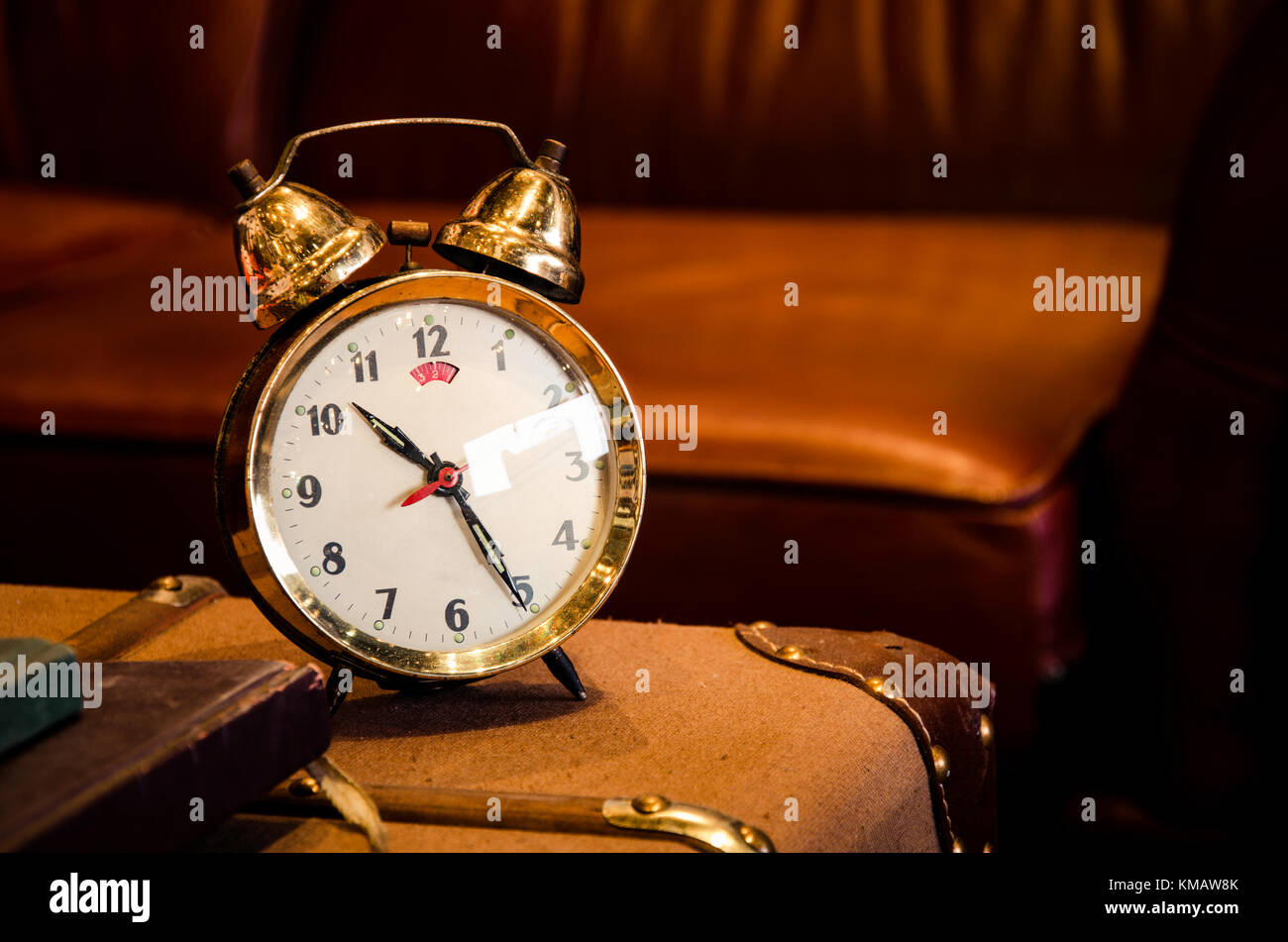 Vintage brass alarm clock on table Stock Photo - Alamy