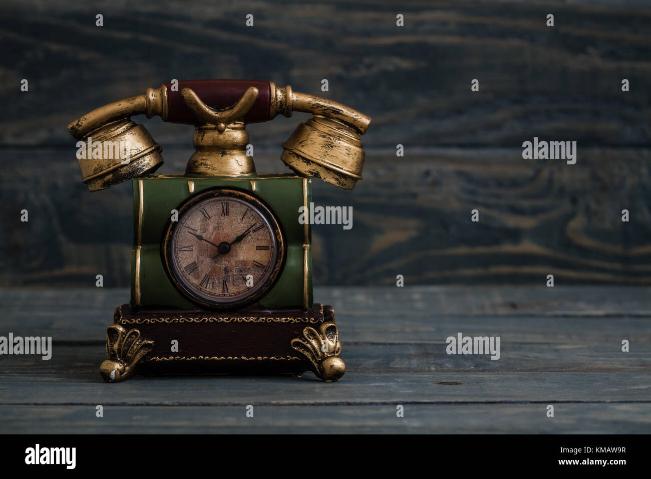 Desk clock with antique telephone design on blue background Stock Photo ...