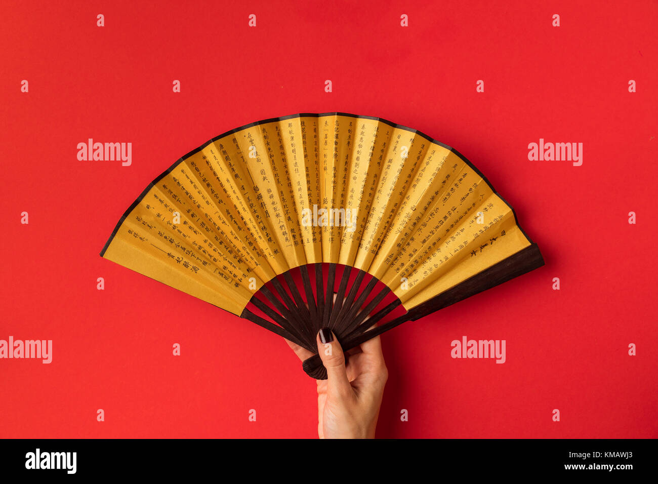 Oriental fan in hand Stock Photo - Alamy