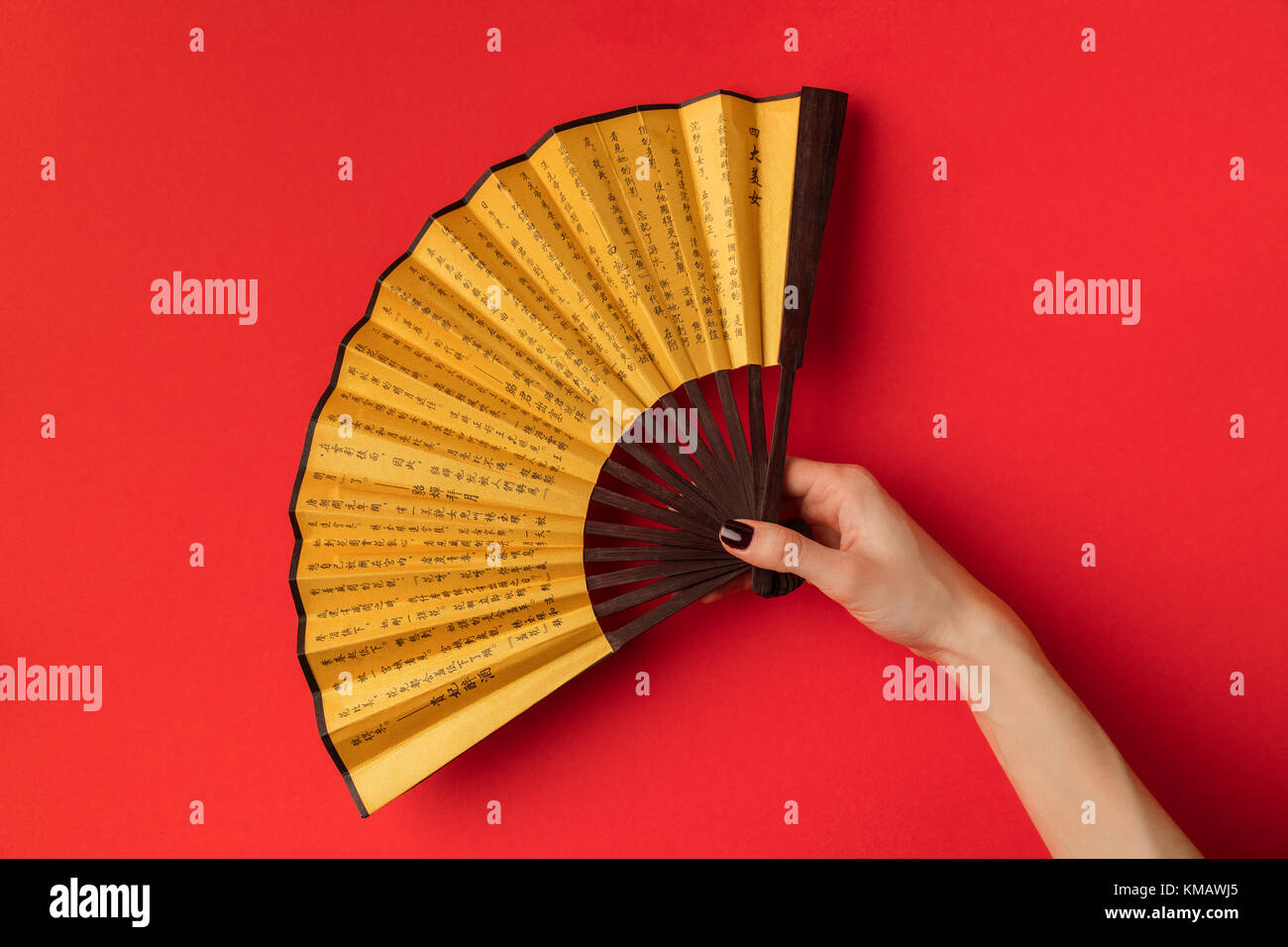 Oriental fan in hand Stock Photo - Alamy