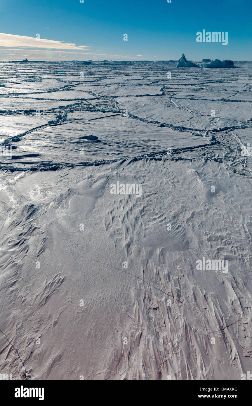 Thick snow-covered pack-ice and trapped icebergs, Antarctica Stock ...