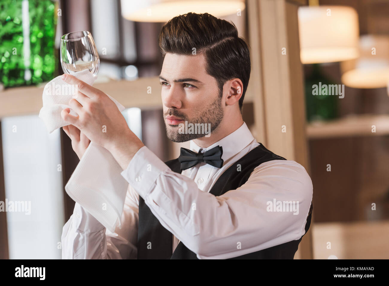 waiter looking at clean wineglass Stock Photo - Alamy