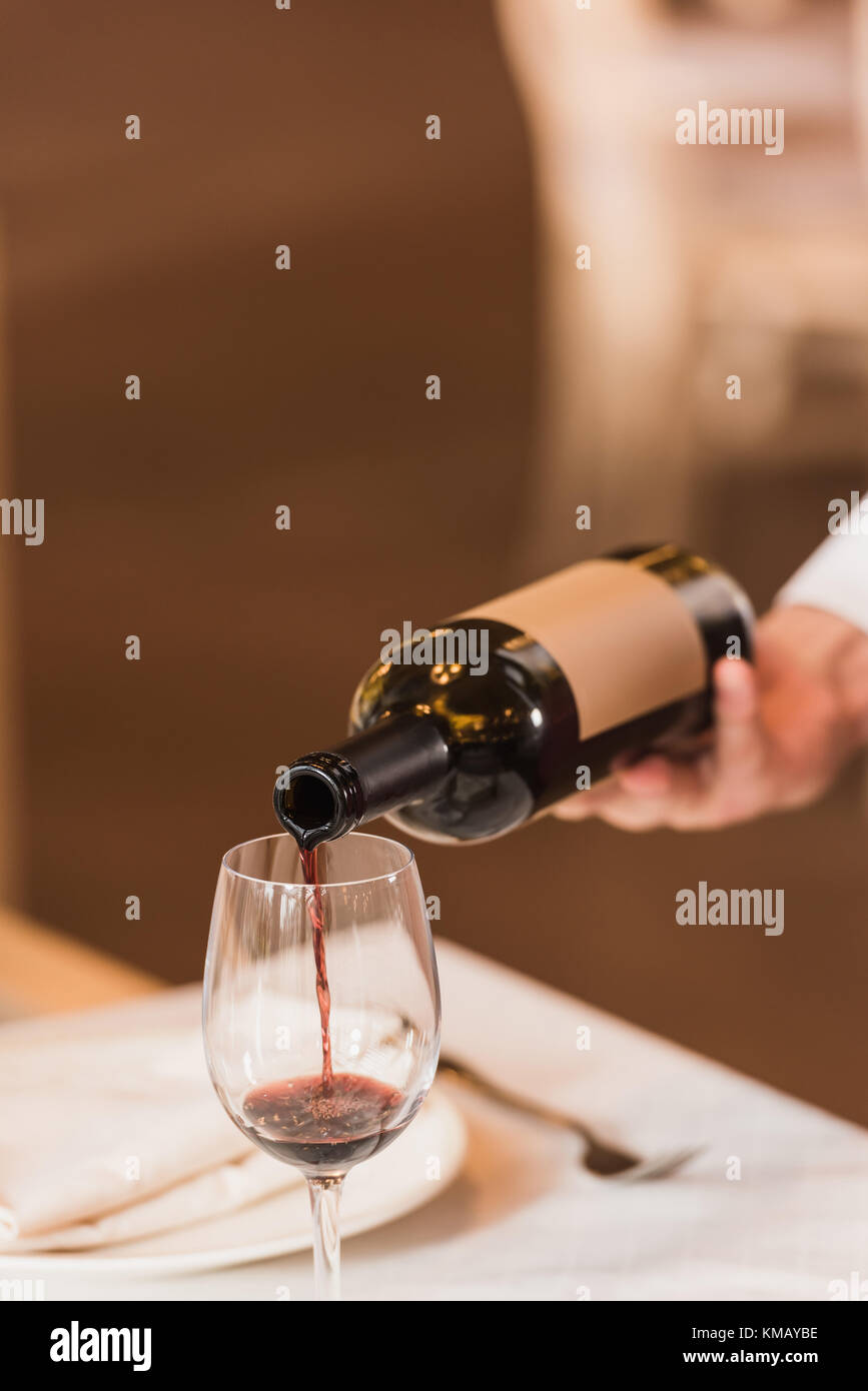 waiter pouring red wine Stock Photo - Alamy