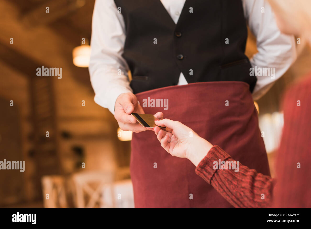 Customer giving credit card to waiter Stock Photo - Alamy