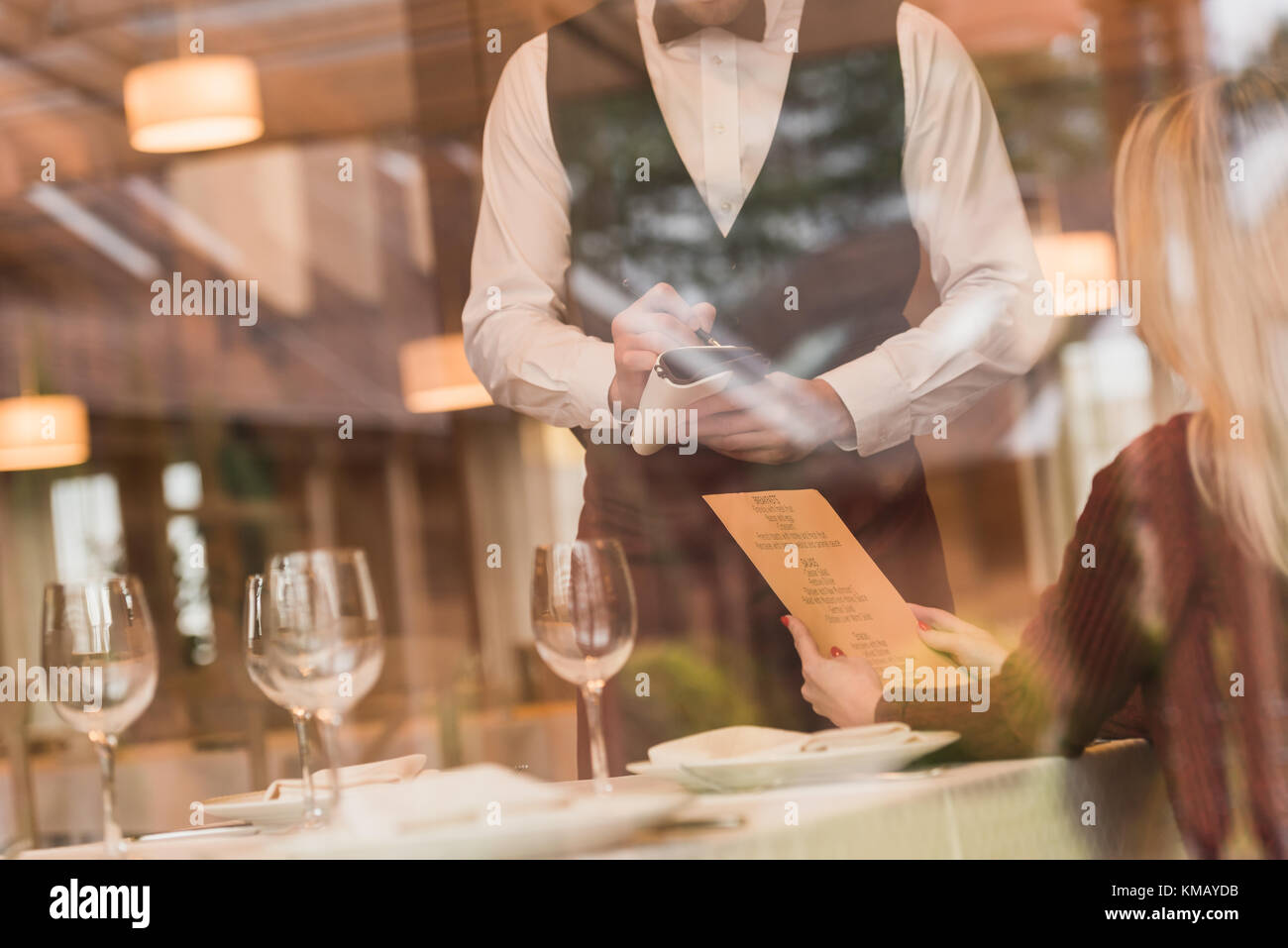 Waiter writing down the order of customer Stock Photo - Alamy