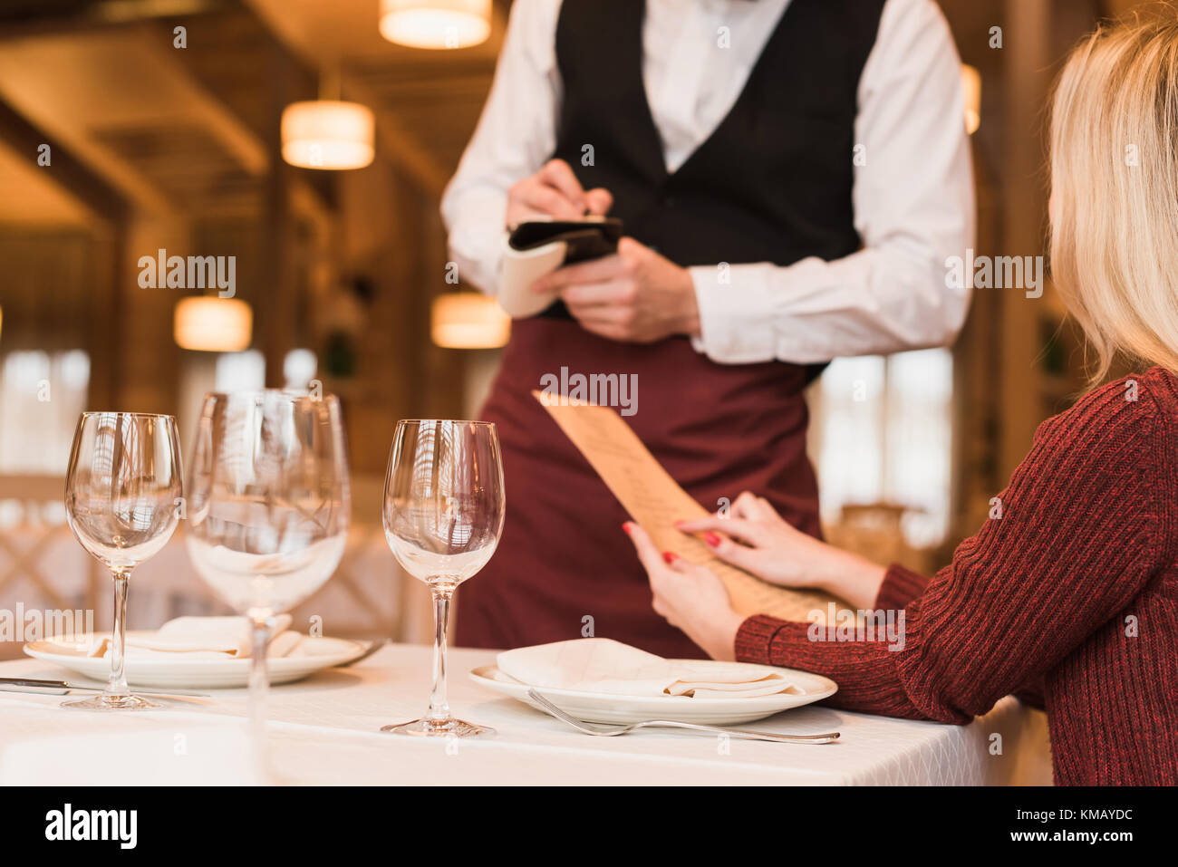 Waiter writing down the order of customer Stock Photo - Alamy