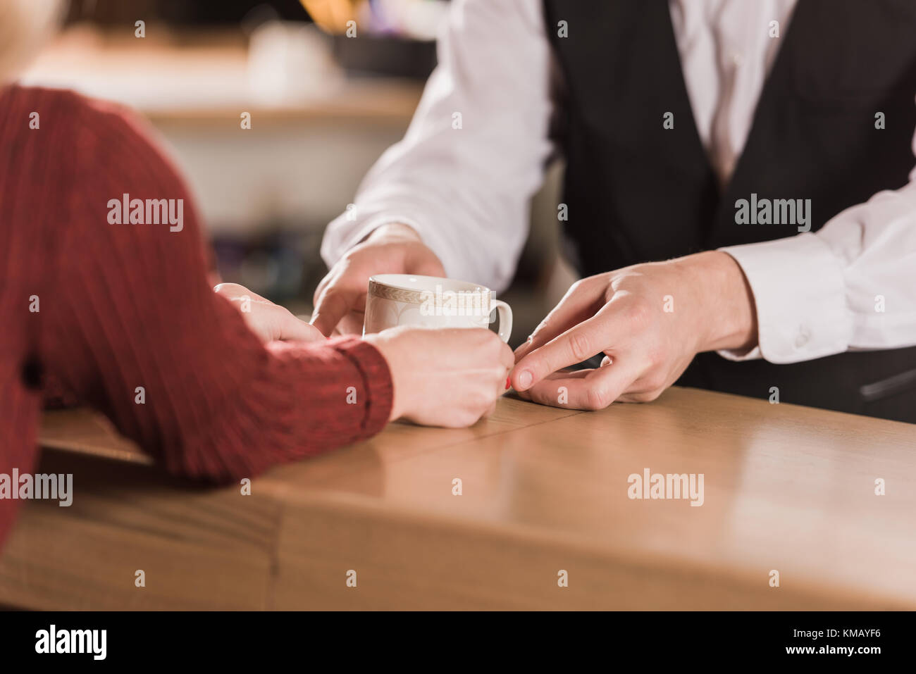 bartender giving cup of coffee to client Stock Photo - Alamy