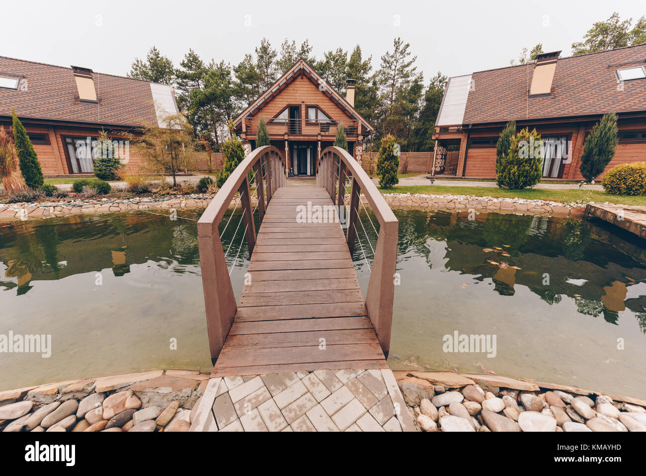 Wooden bridge over pond Stock Photo - Alamy