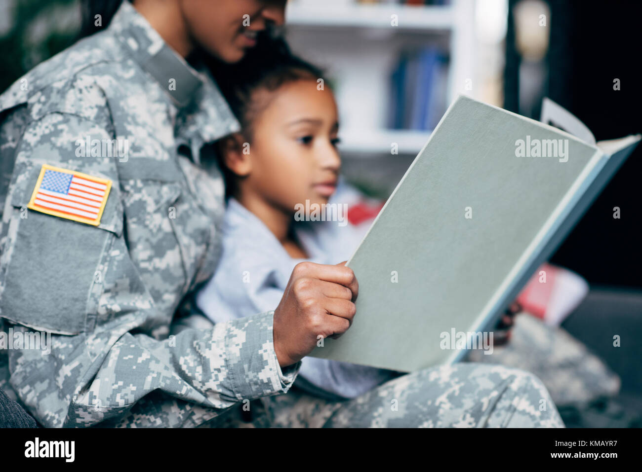 daughter and mother in military uniform with book Stock Photo - Alamy