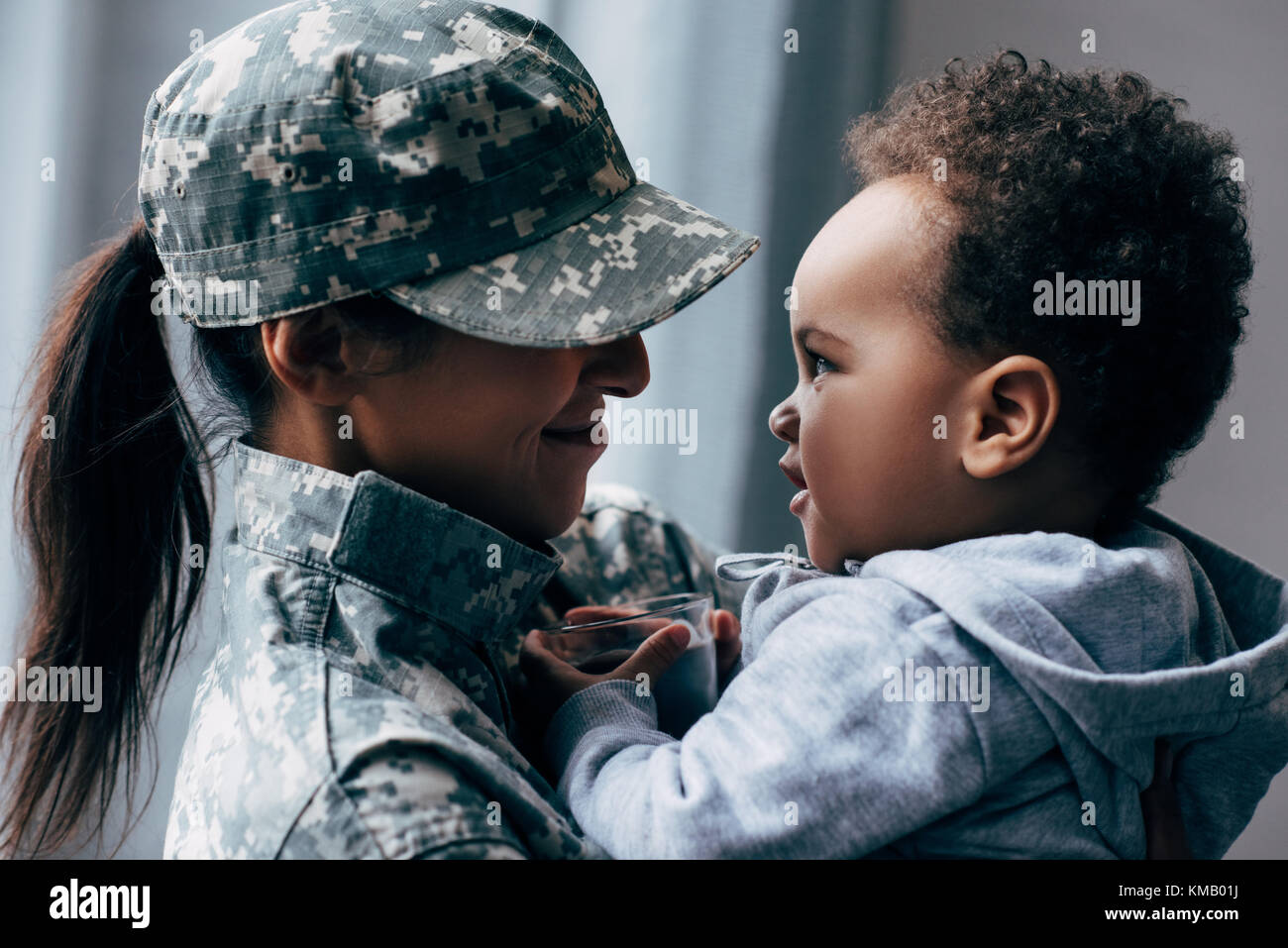 mother in military uniform with little son Stock Photo - Alamy